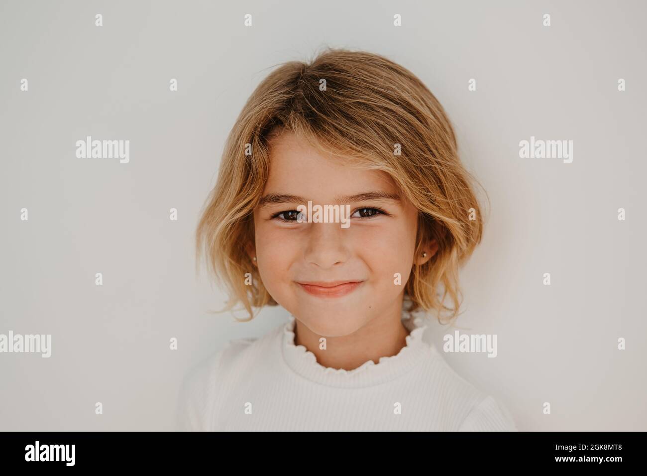 Friendly cute child with brown hair looking at camera Stock Photo - Alamy
