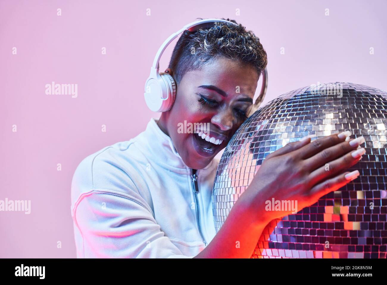 Cool ethnic cheerful Woman with short hair in wireless headset and ...