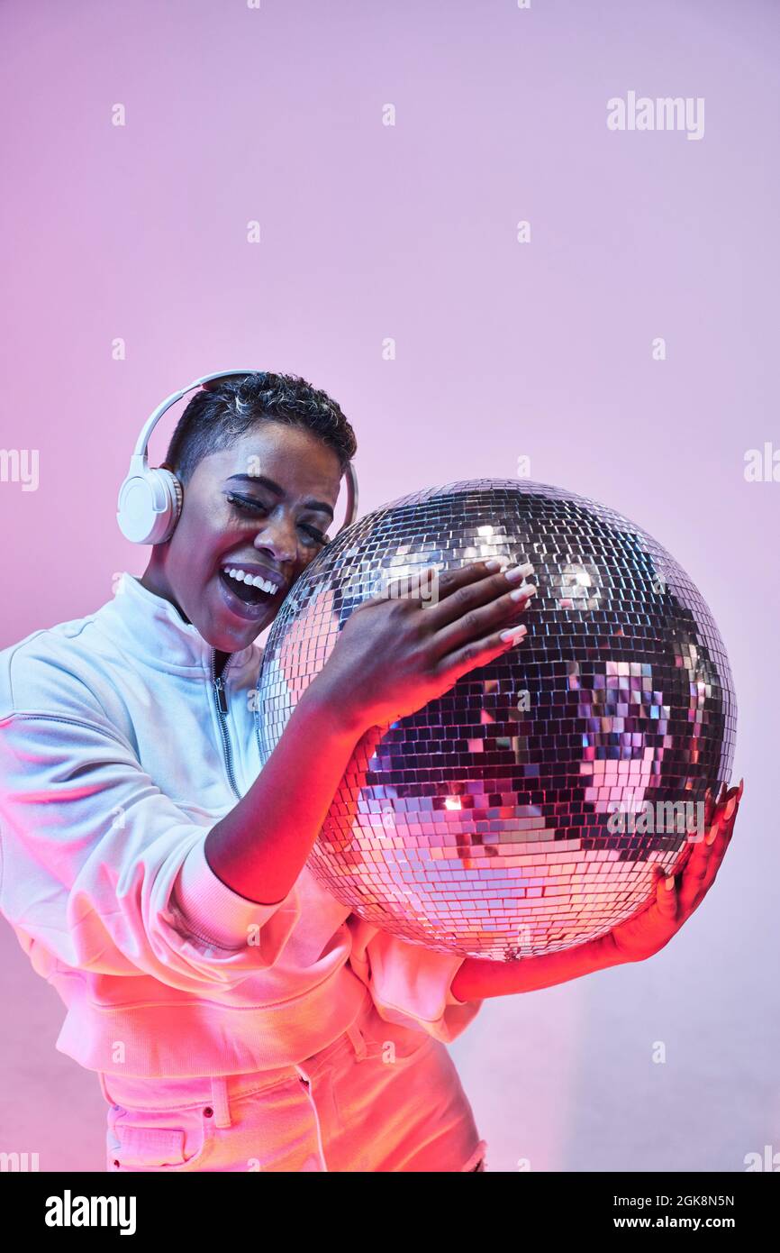 Cool ethnic cheerful Woman with short hair in wireless headset and ...