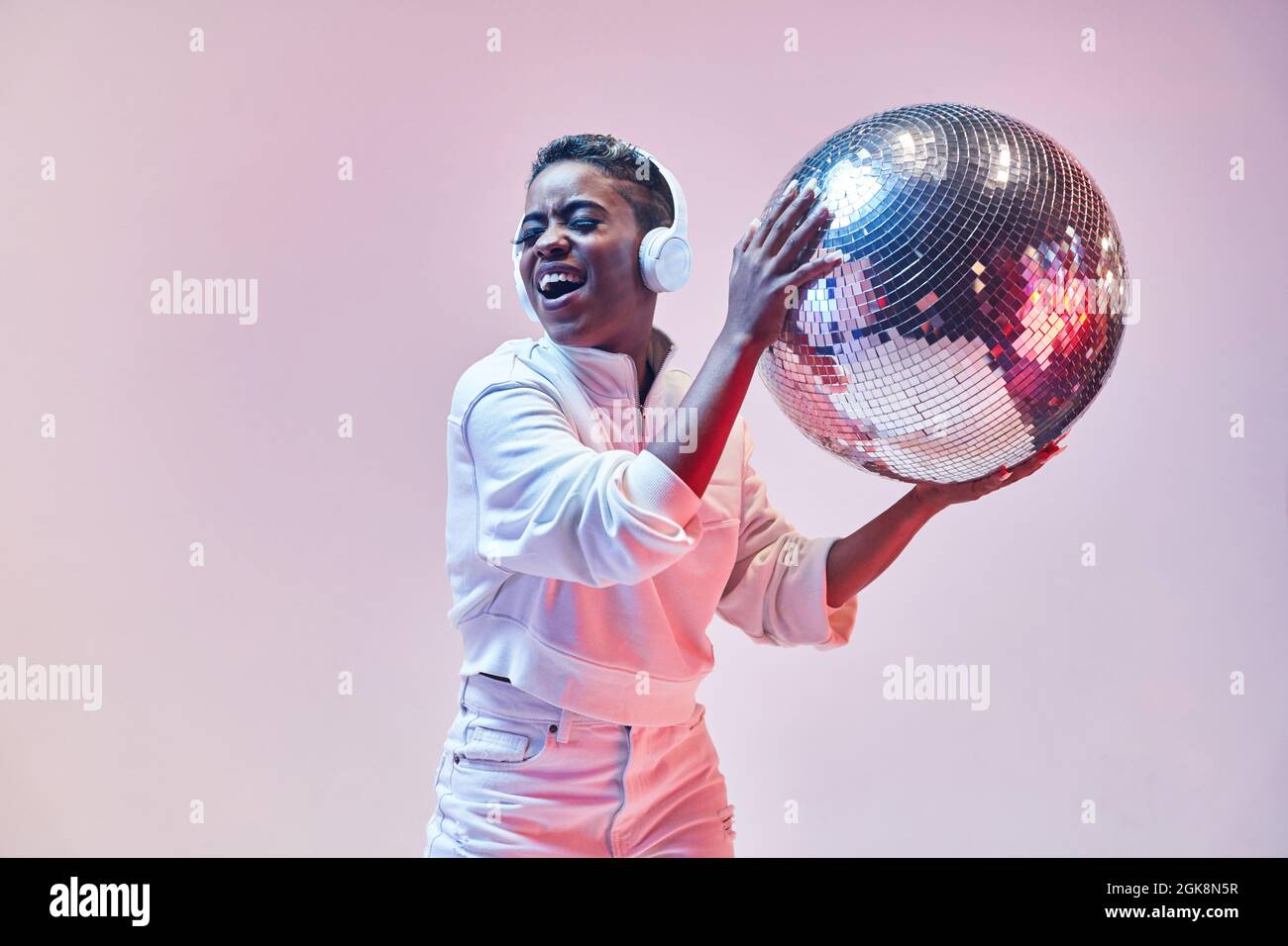 Cool ethnic cheerful Woman with short hair in wireless headset and ...