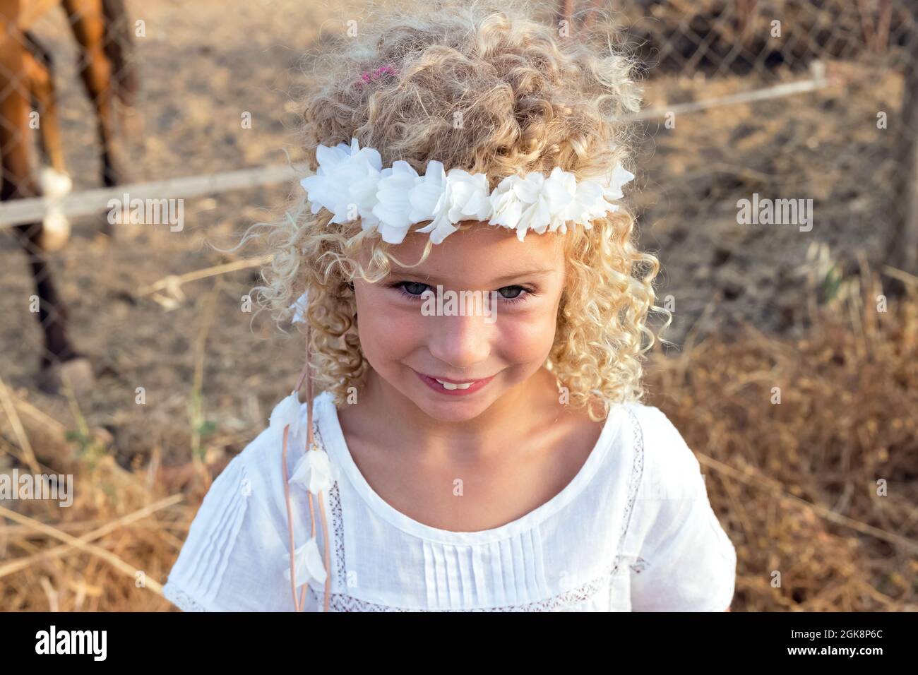 Little blonde girl alone in a field on a sunny day Stock Photo - Alamy