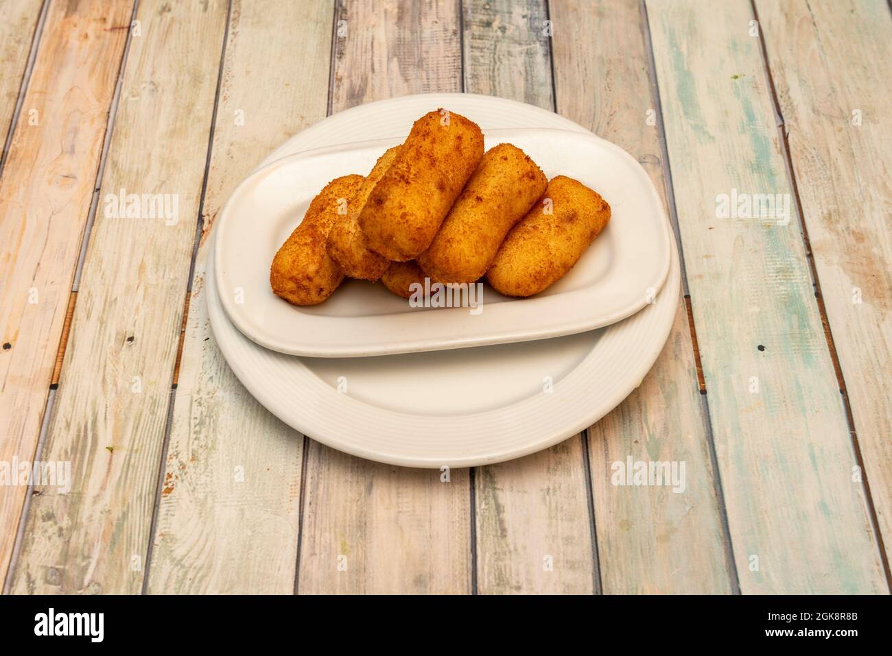 serving of cod croquettes typical of a Spanish tapas bar on white ...