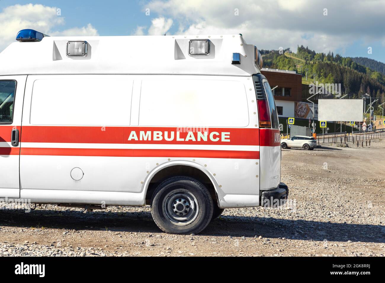 Side view of white ambulance rescue ems van car parked near countryside ...
