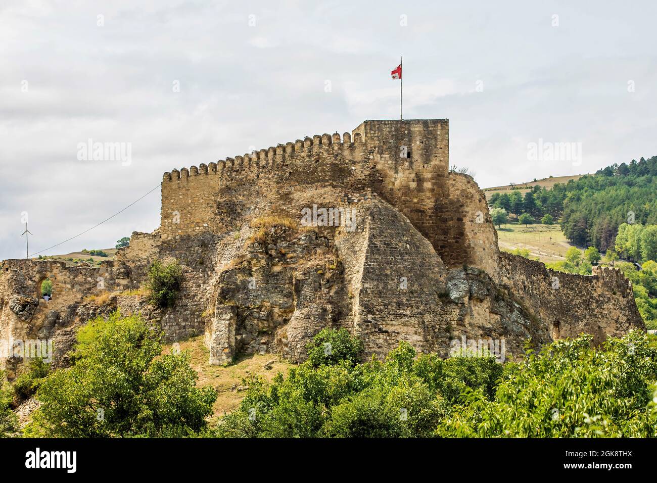 Close up view of Surami Fortress in Georgia with flag in summer day ...