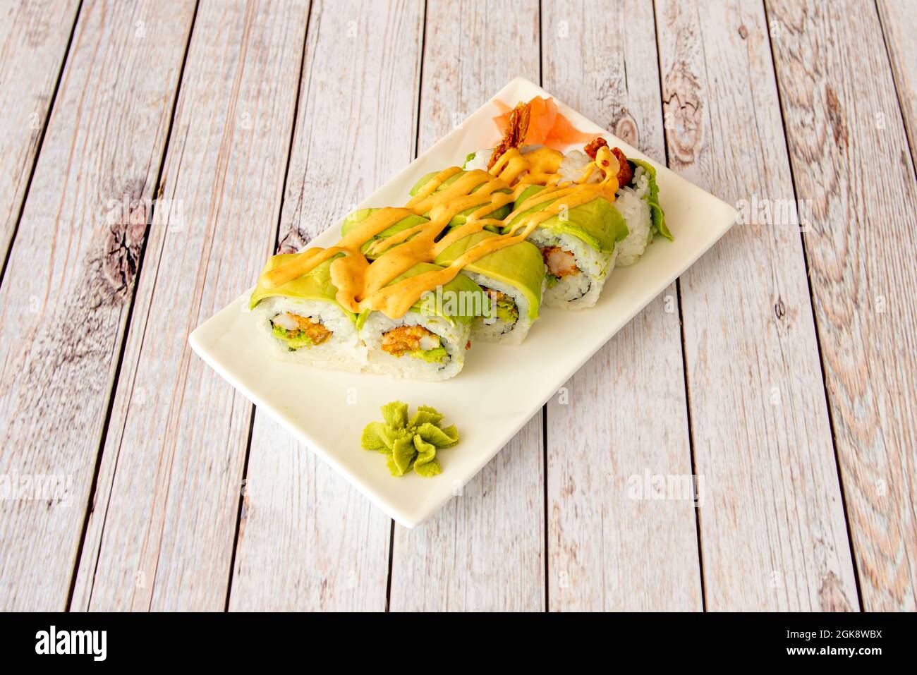 Uramaki dragon prawn with wasabi, avocado in sheets, ginseng and sauce ...