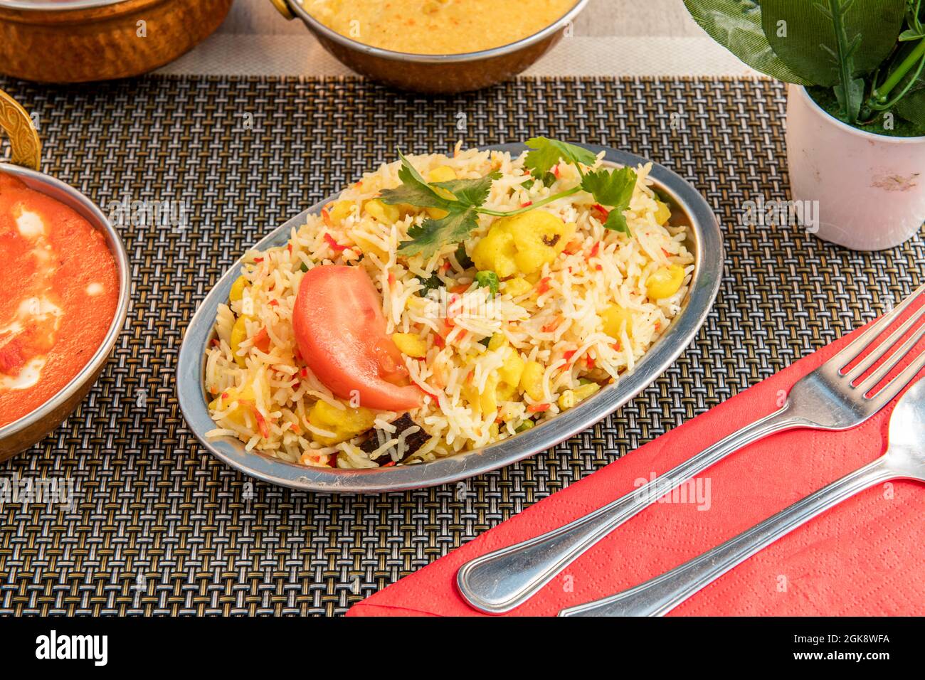 metal tray of rice with vegetables made with a recipe from a Pakistani ...
