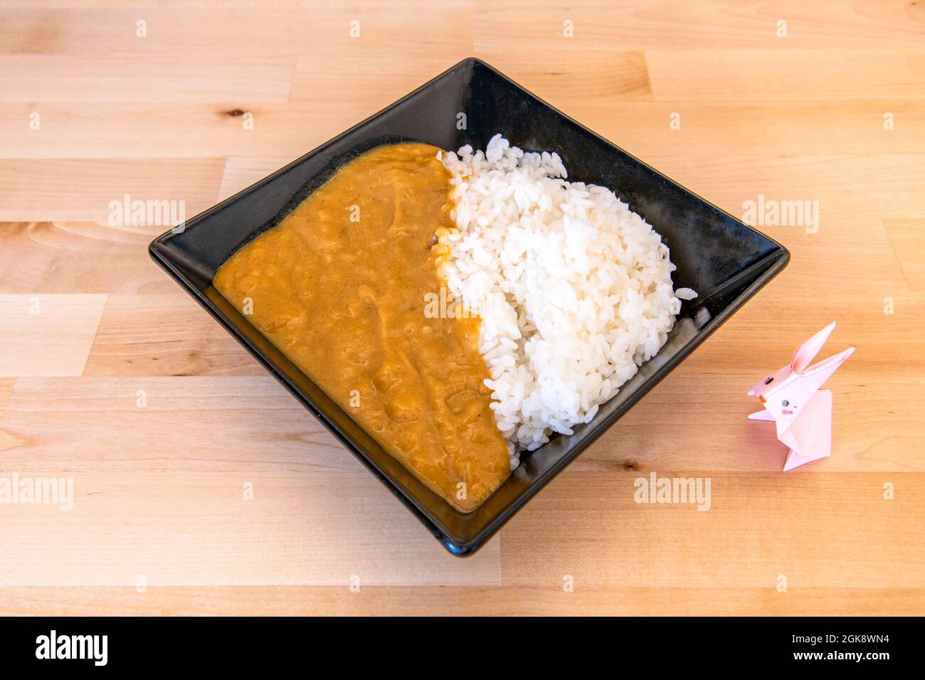 Super yellow chicken curry with coconut and white rice garnish with ...