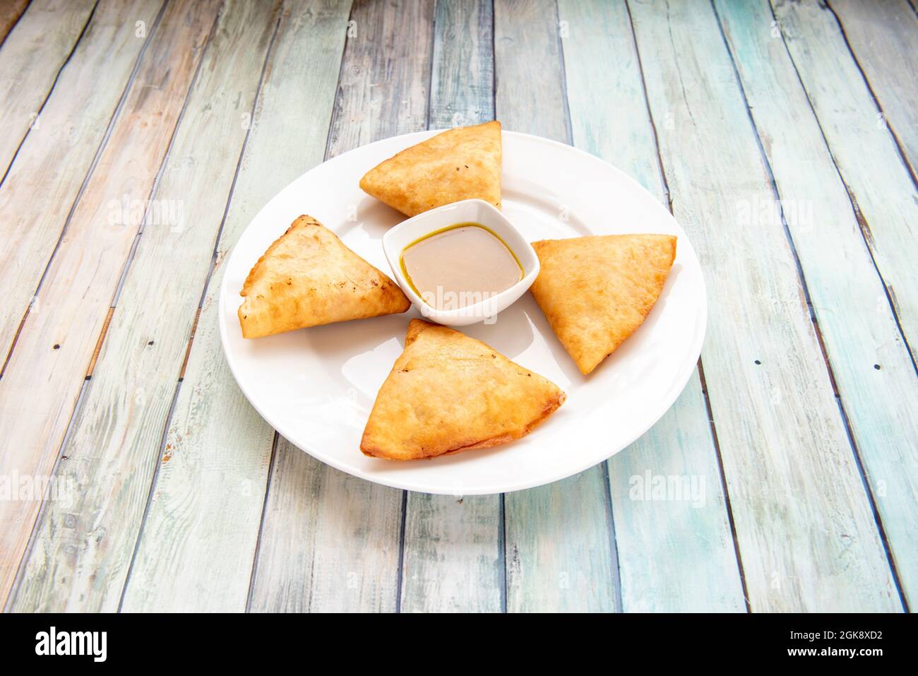 Portion of Mexican Mayan empanadas with dip sauce on a bank plate Stock ...