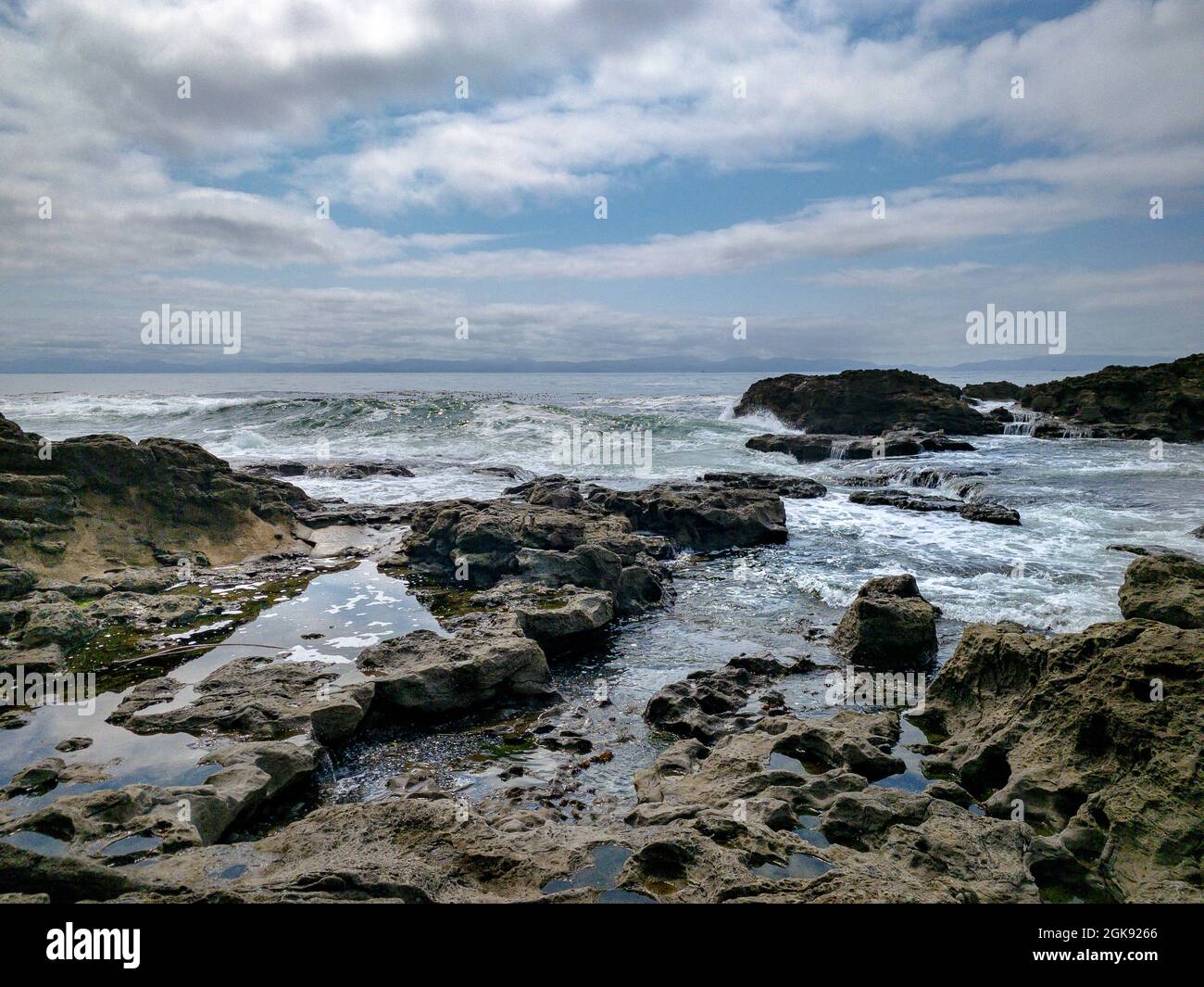 Tidepools formed in sandstone and waves in the intertidal zone of ...