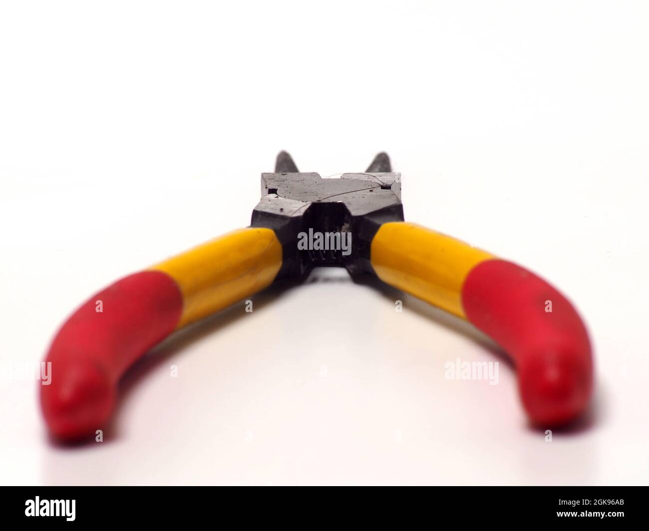 Picture of snap ring plier that has a yellow - red handle. Shoot on ...