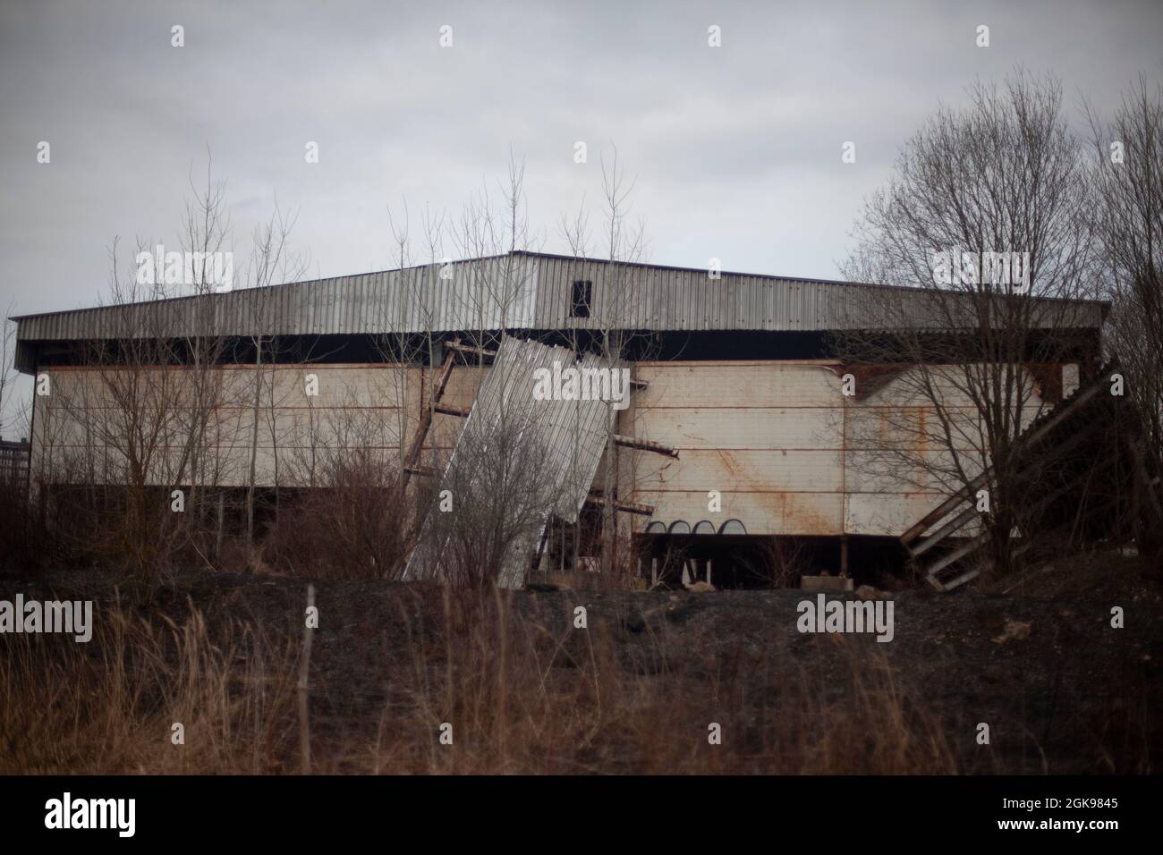 View of an abandoned building. An old warehouse. Rusty building in the ...