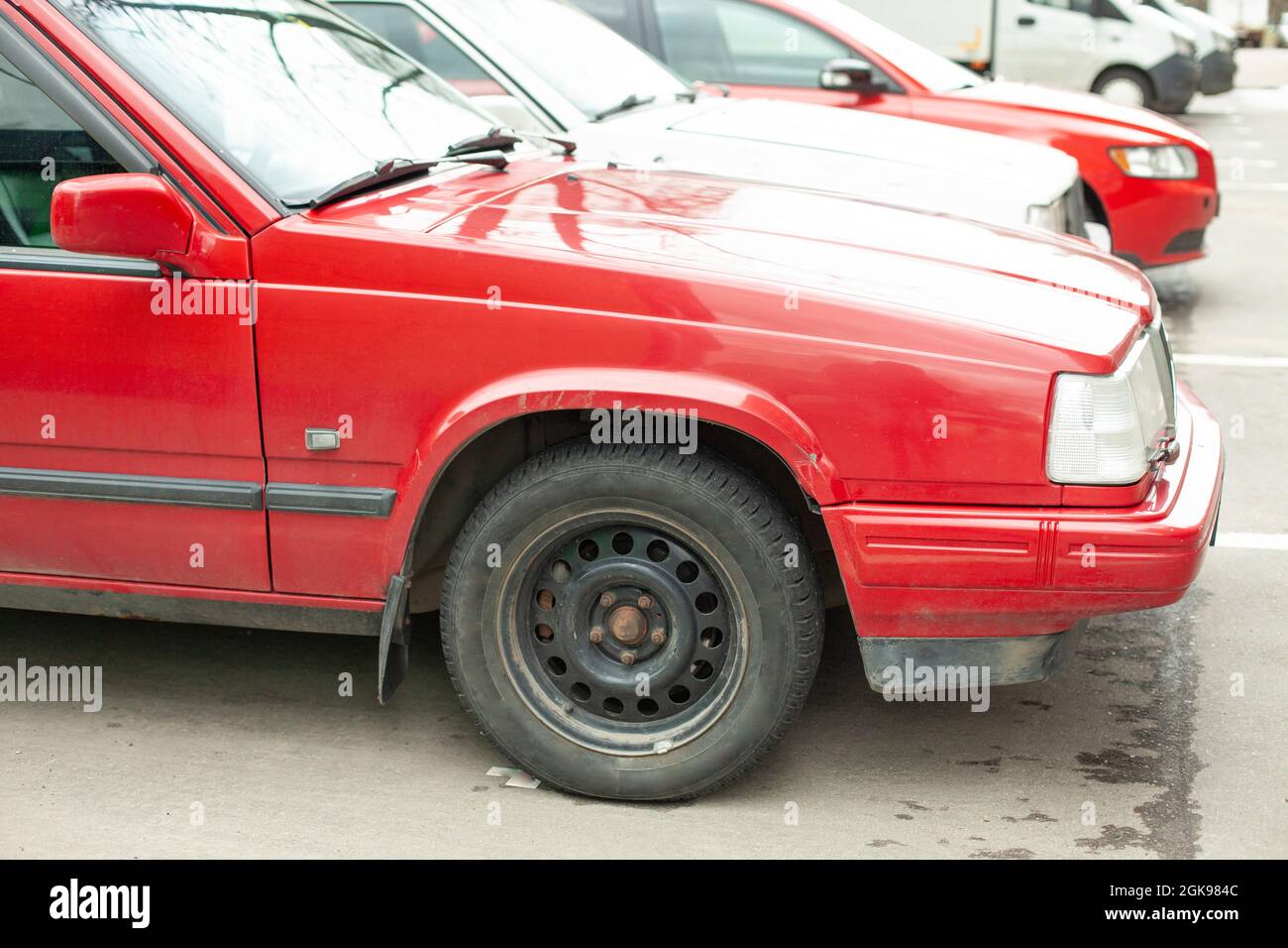 Red German car in the parking lot. Wheel on the transport. The car is ...