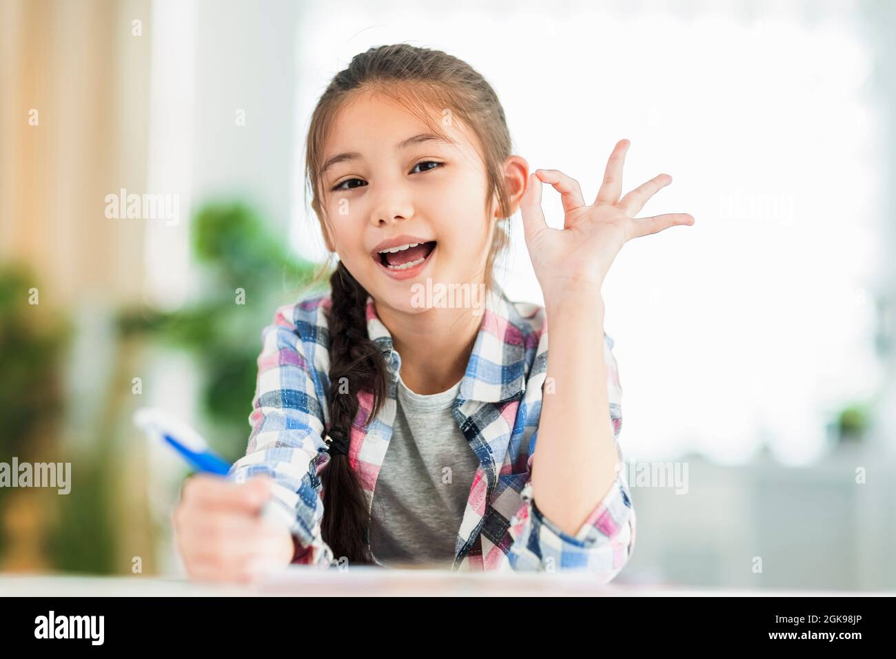 Happy student girl study. Showing ok gesture Stock Photo - Alamy