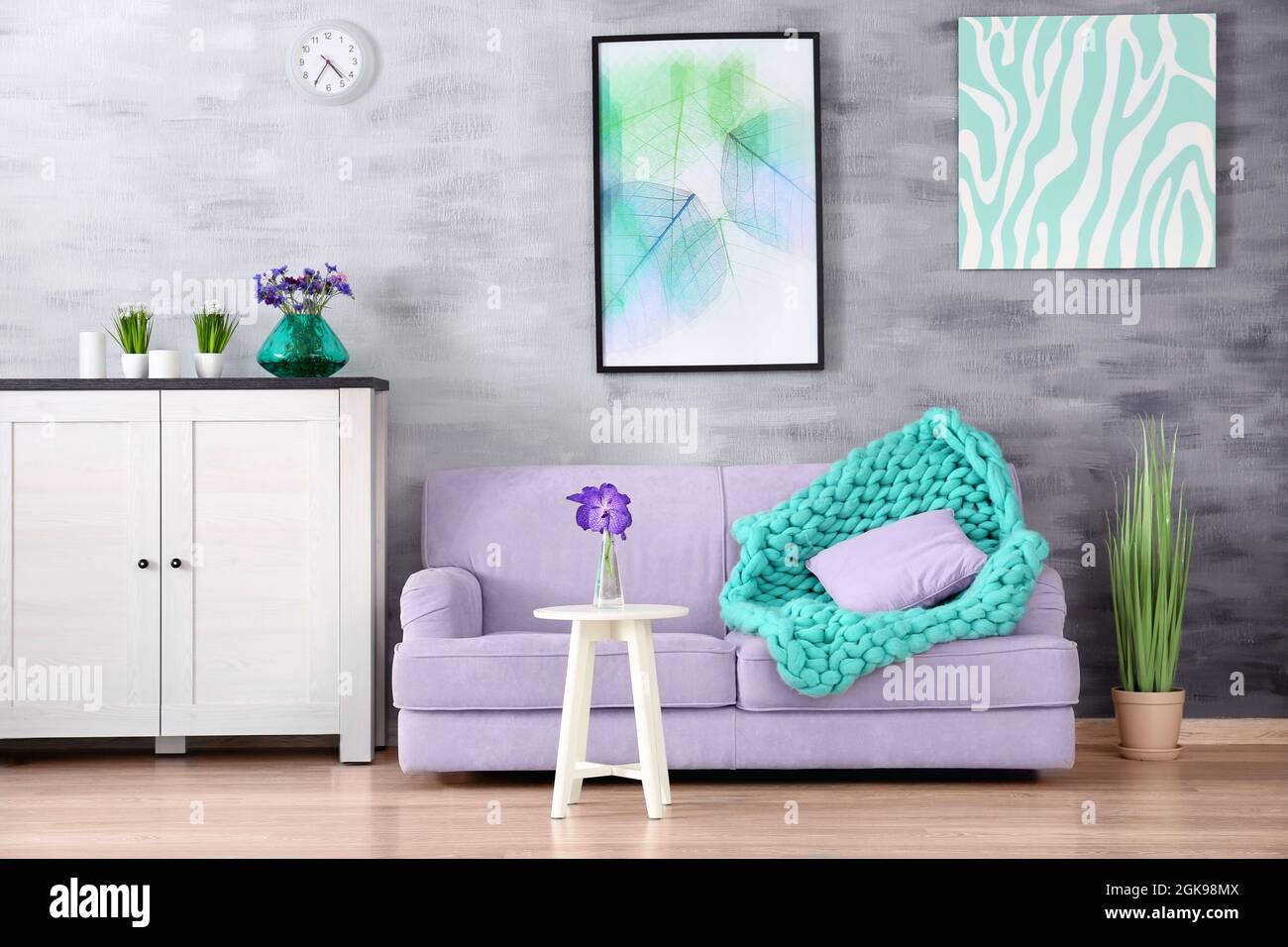 Lilac accent in modern interior. Comfortable couch in living room Stock ...