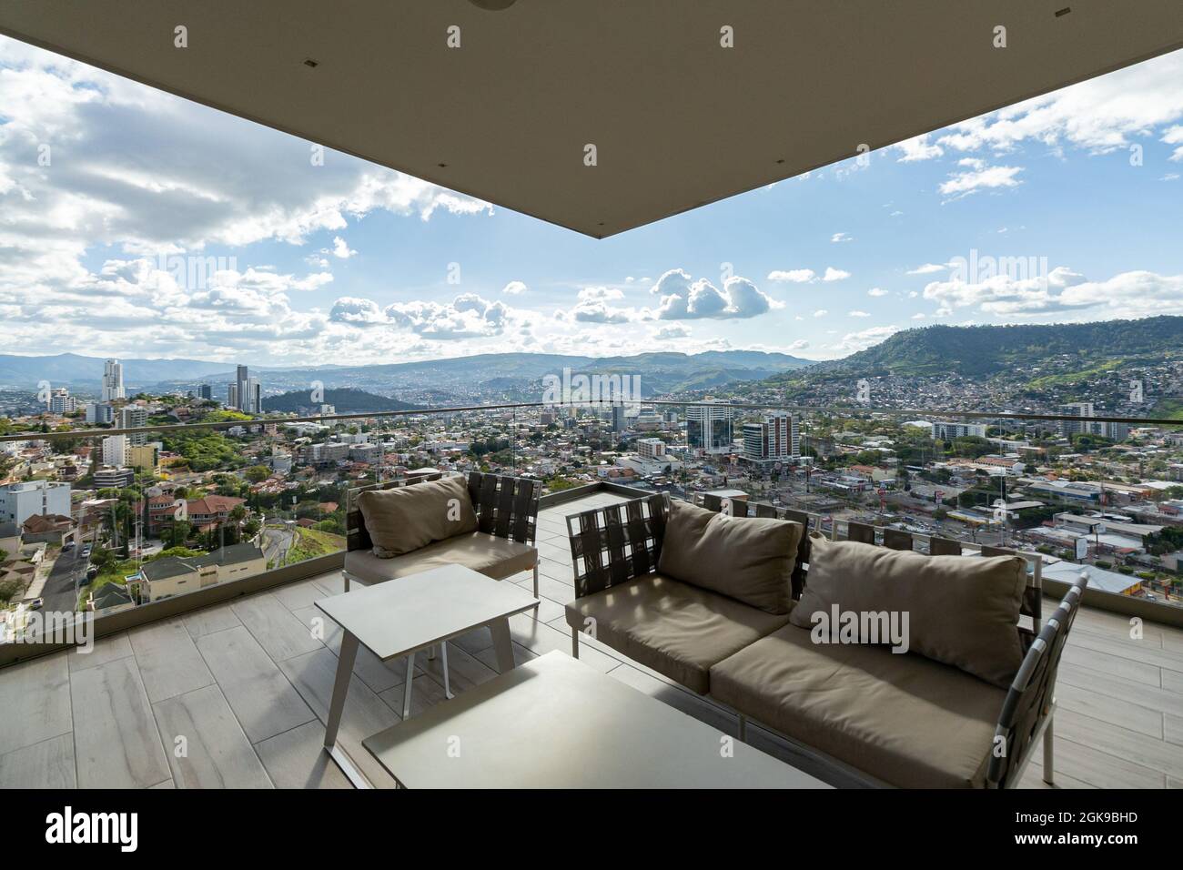 View of a rooftop and the beautiful town with hills and mountains in ...