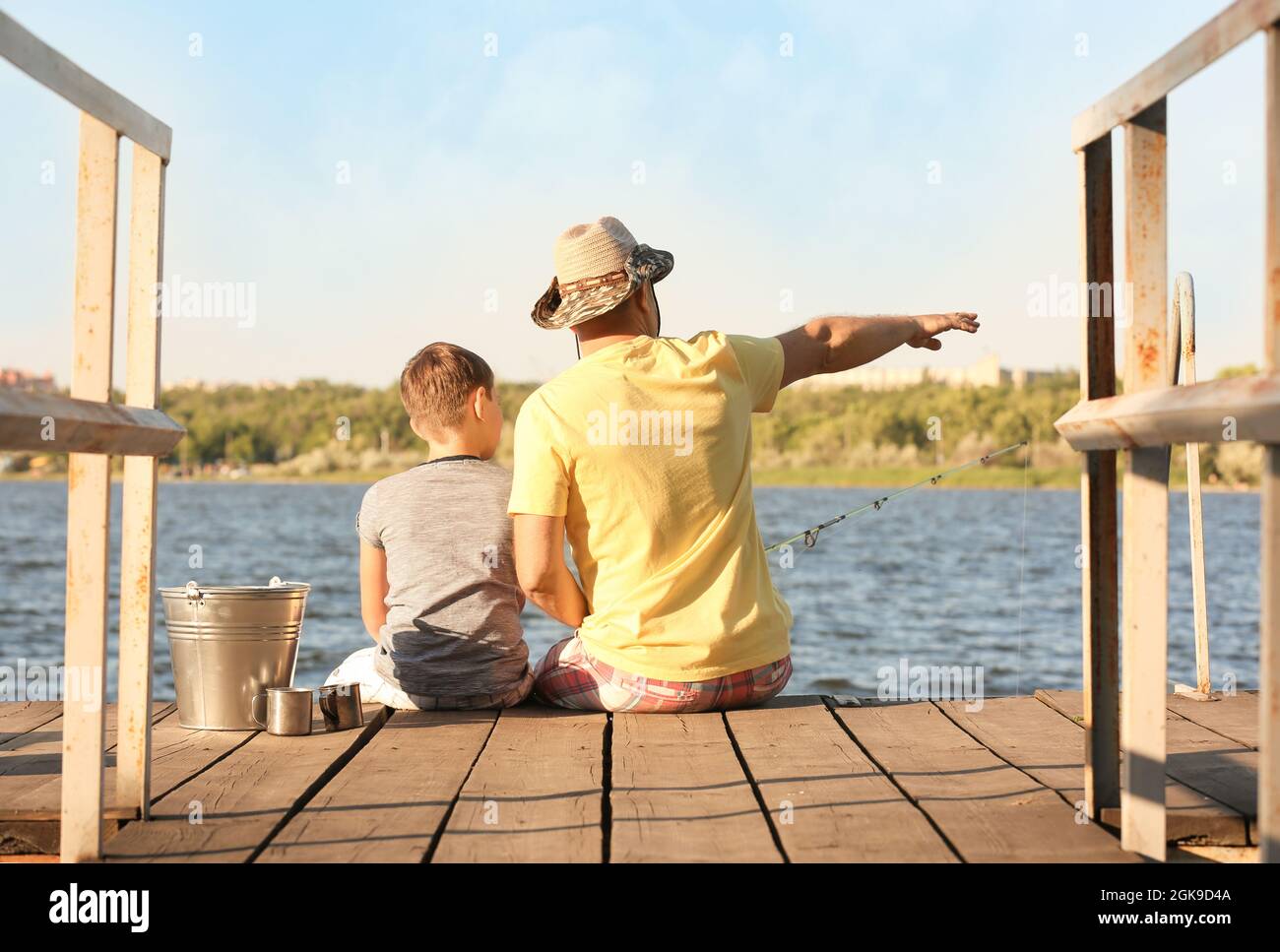Man sitting on bucket fishing hi-res stock photography and images - Alamy