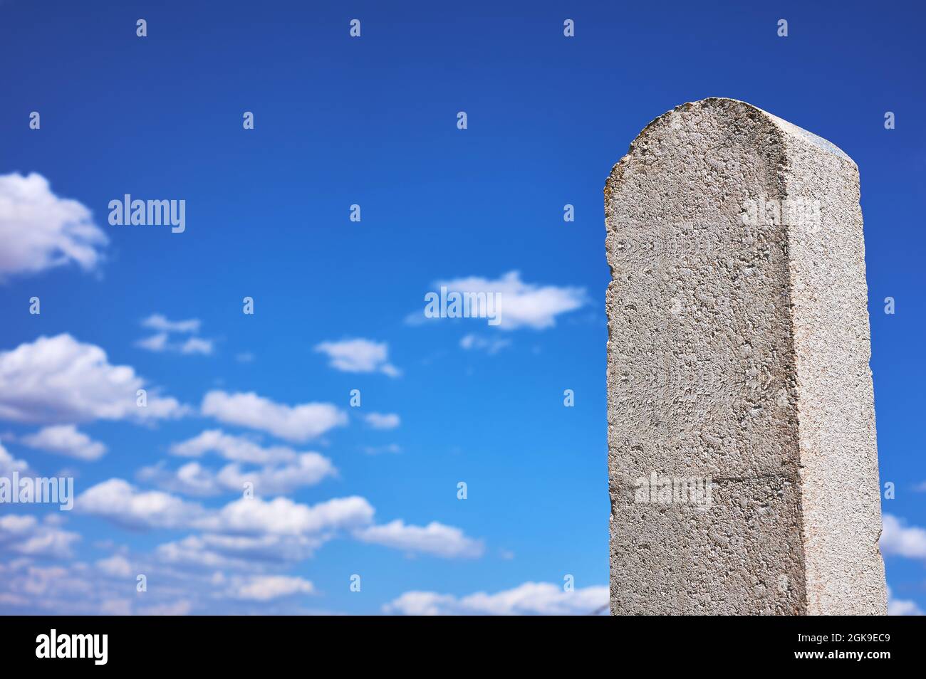 detail of a pylon or stone milestone delimiting a separation on a road ...