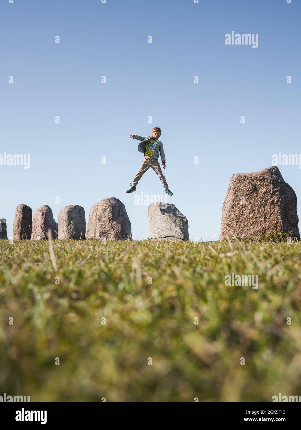 Children jumping off a rock hi-res stock photography and images - Alamy