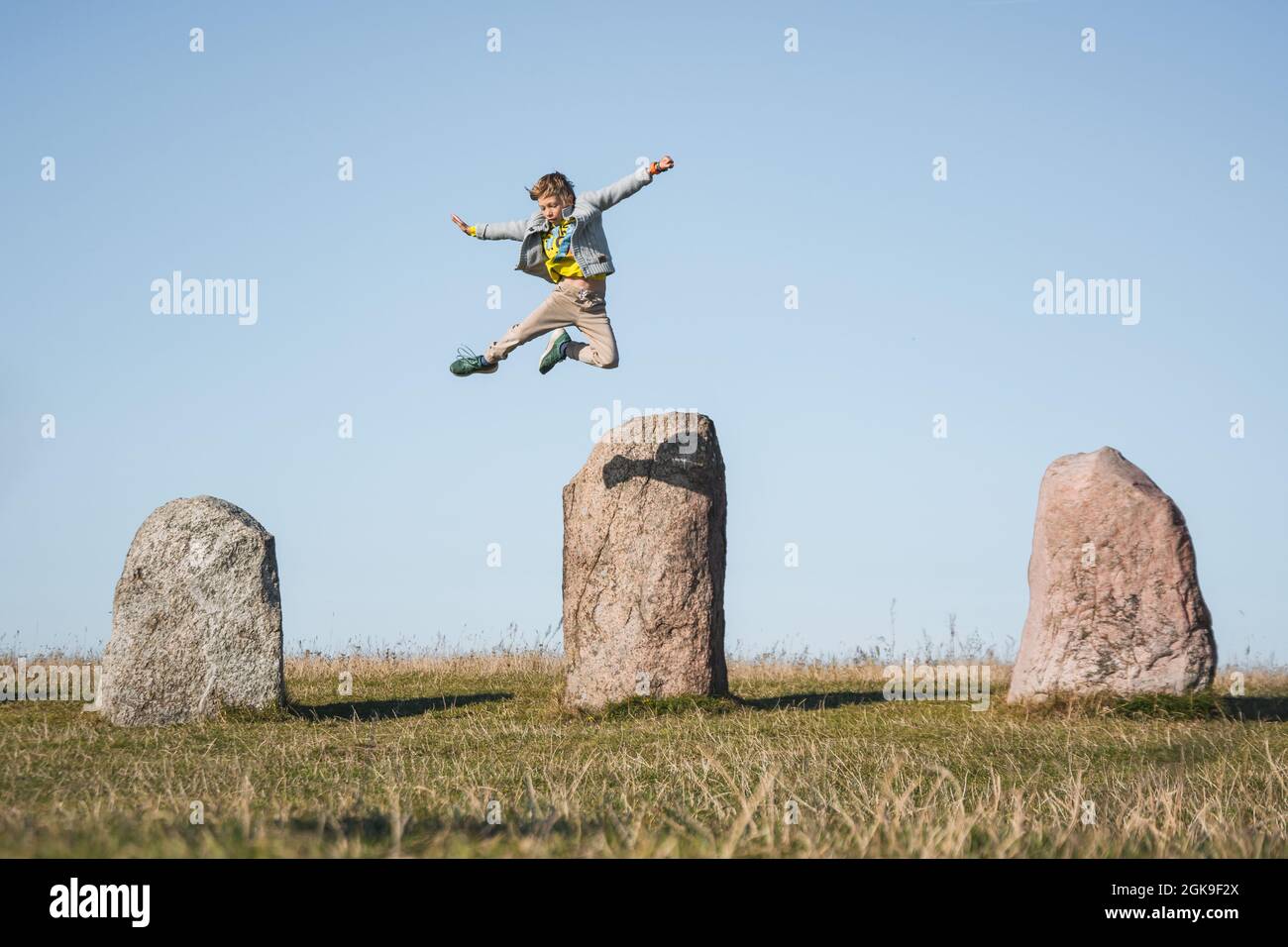Children jumping off a rock hi-res stock photography and images - Alamy