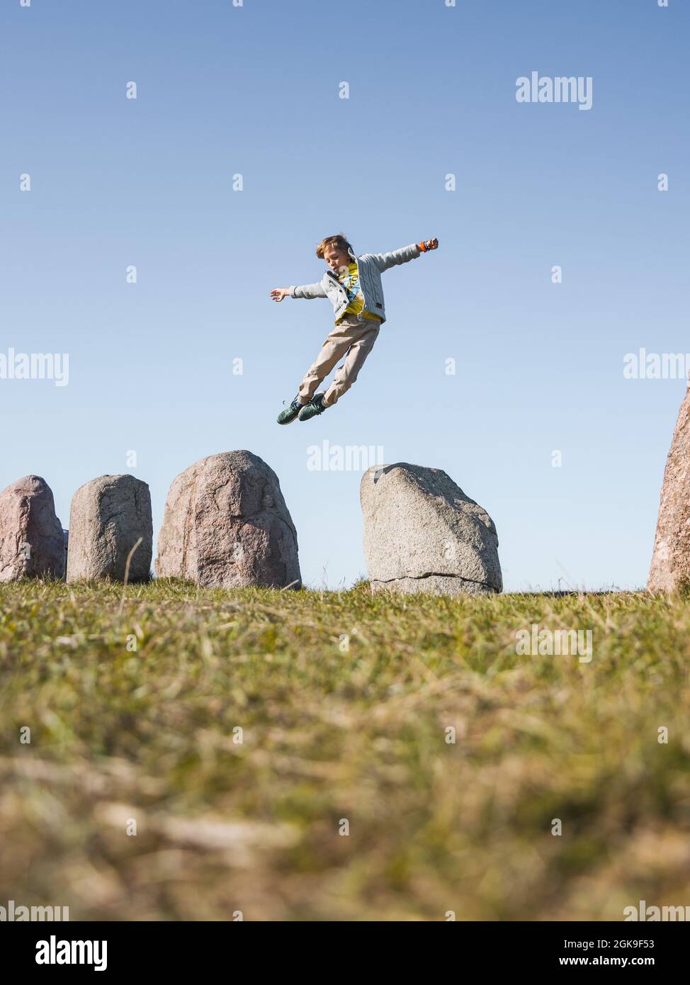 Children jumping off a rock hi-res stock photography and images - Alamy