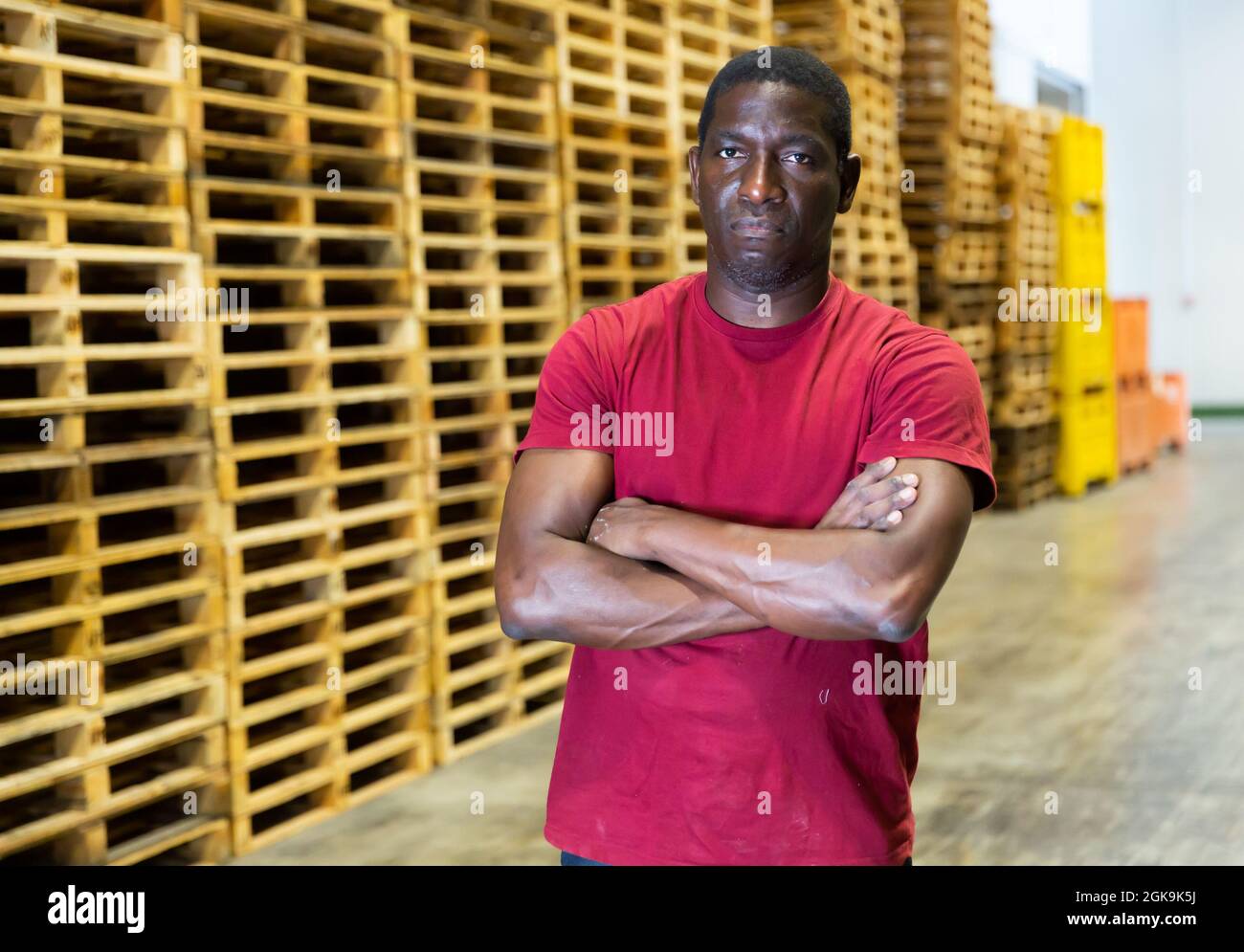 Portrait of afro man worker in warehouse Stock Photo - Alamy