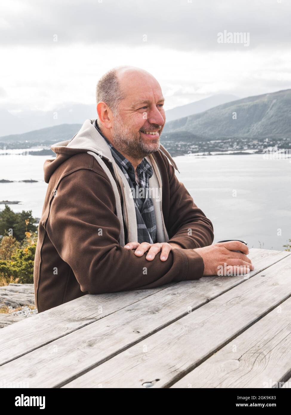 Attractive bald middle aged man sitting hi-res stock photography and ...