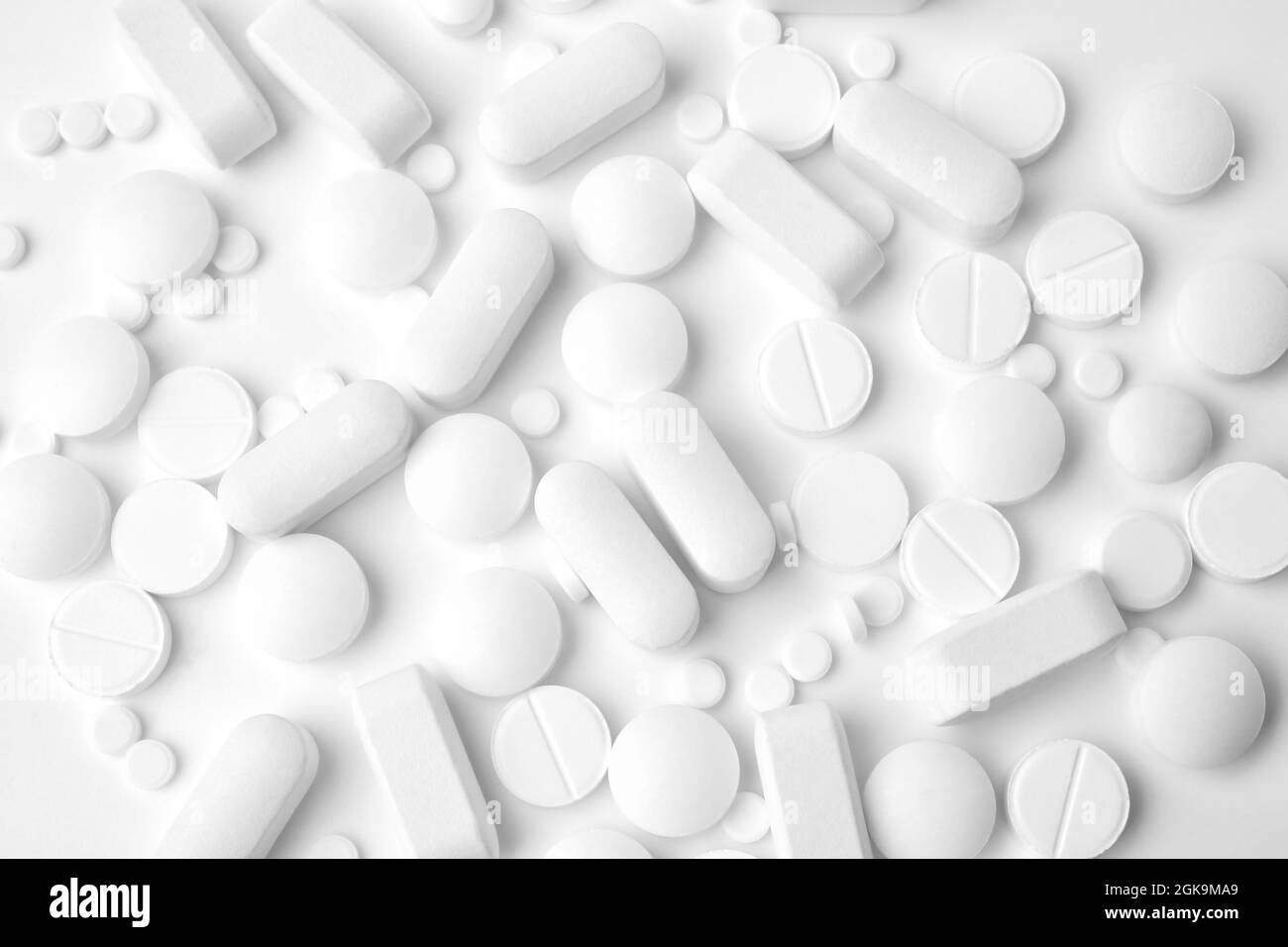 Pile of different pills on white background Stock Photo - Alamy