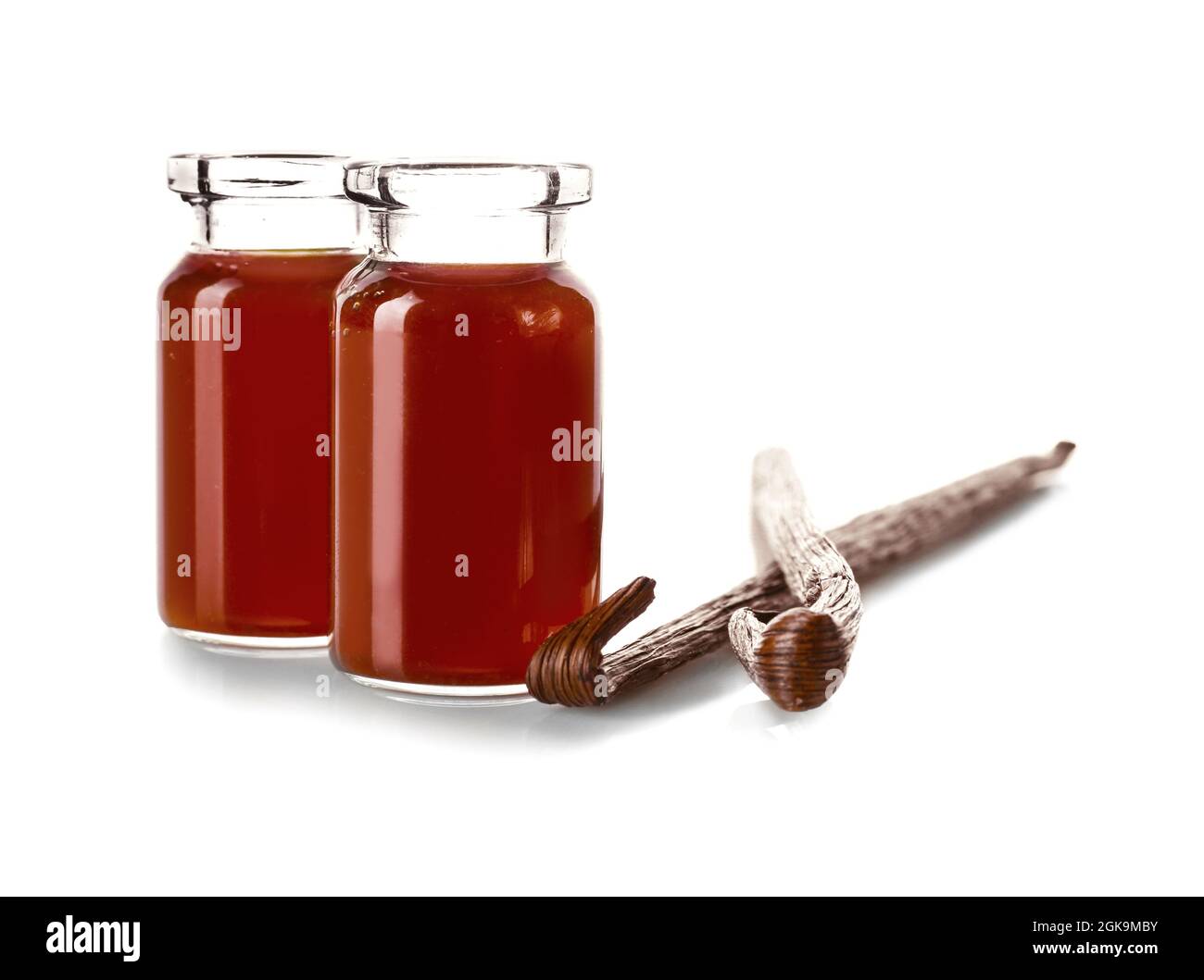 Bottles with vanilla extract and sticks on white background Stock Photo ...