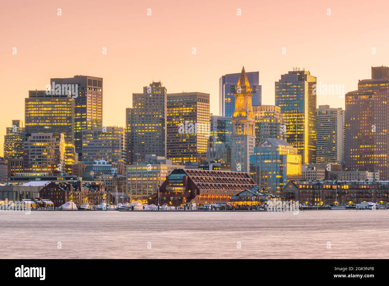 Panorama view of Boston skyline with skyscrapers over water at twilight ...