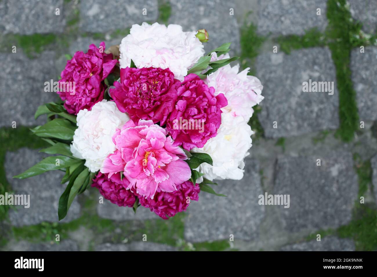 Beautiful bouquet of peonies on paving stones, outdoors Stock Photo - Alamy