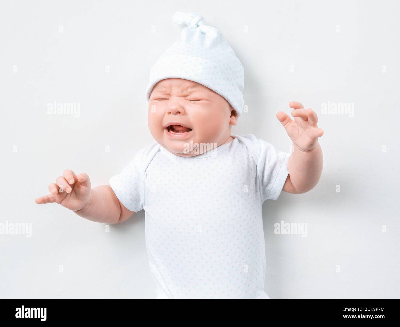Crying newborn baby on white background Stock Photo - Alamy