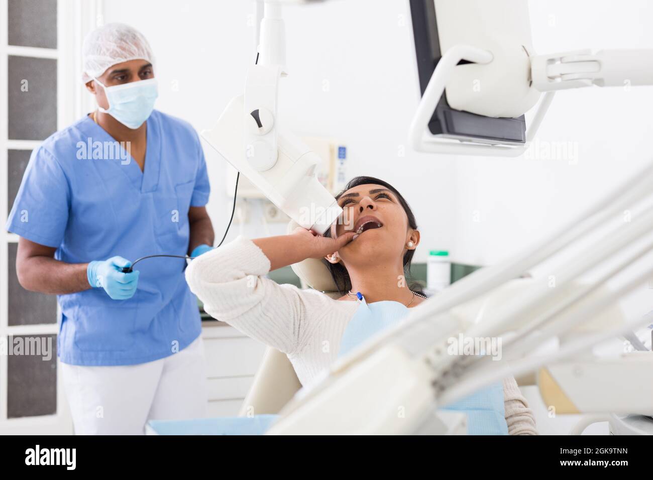 Dentist makes x-ray of patients teeth Stock Photo - Alamy