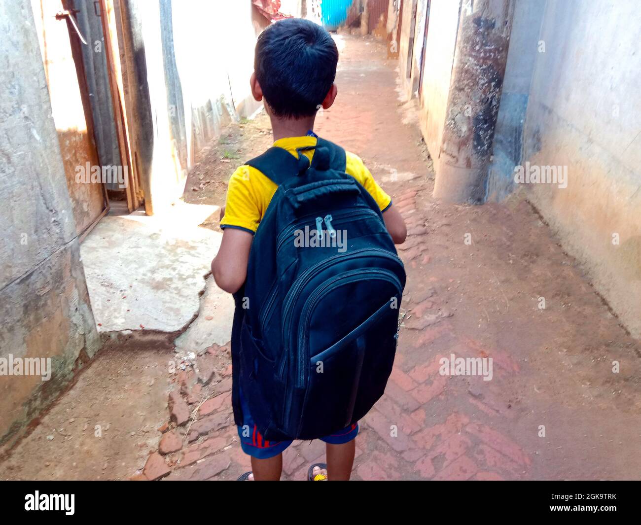 a school student going to classroom with bag and books for reading and ...
