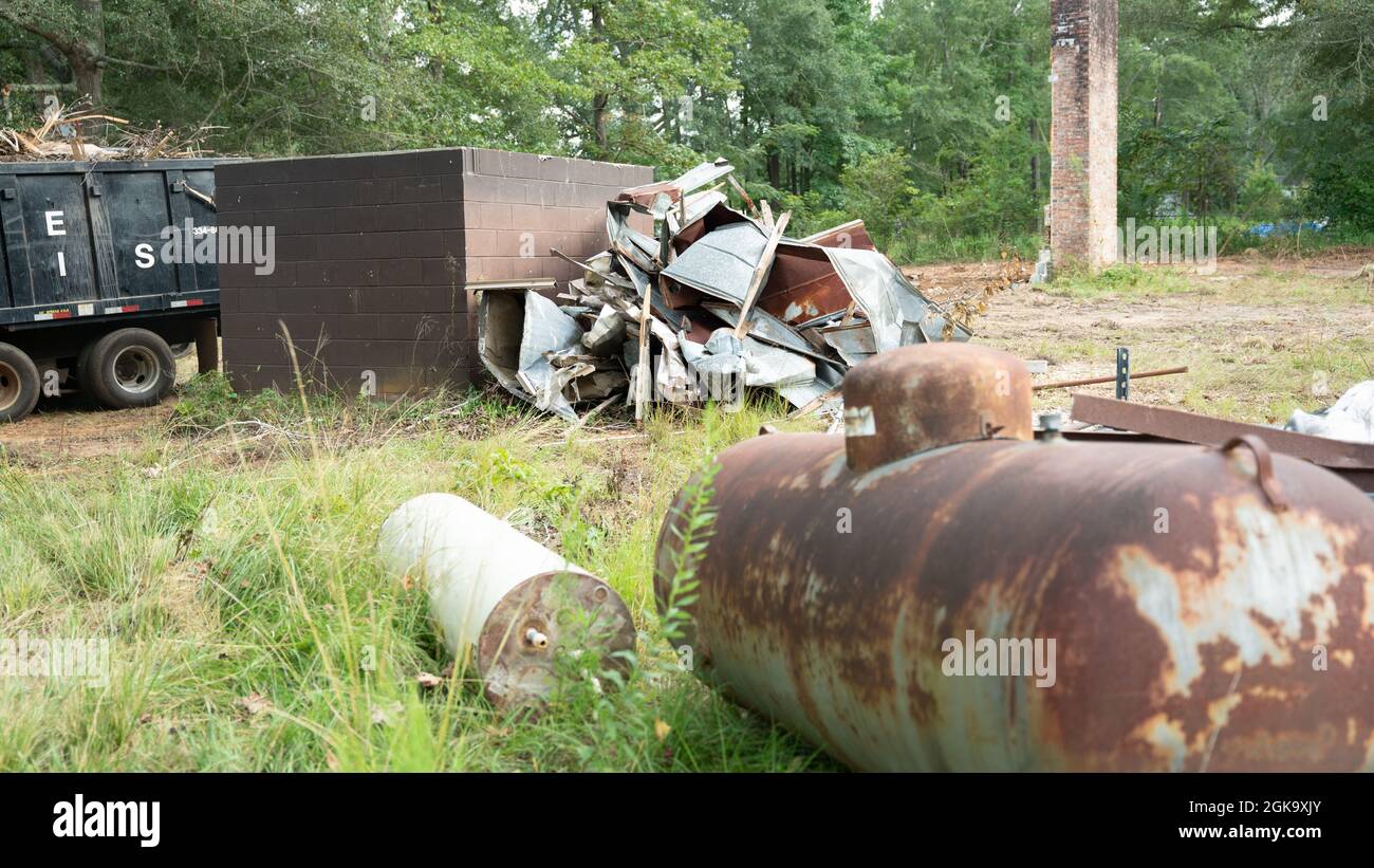 yellow yanmar backhoe demolishing old brick chimney to clear a lot ...