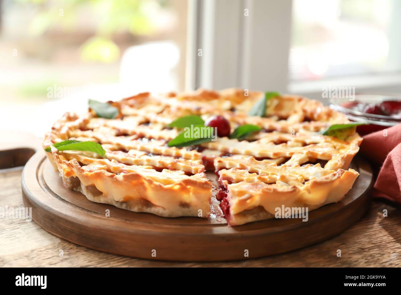 Wooden board with delicious cherry pie on window sill Stock Photo - Alamy