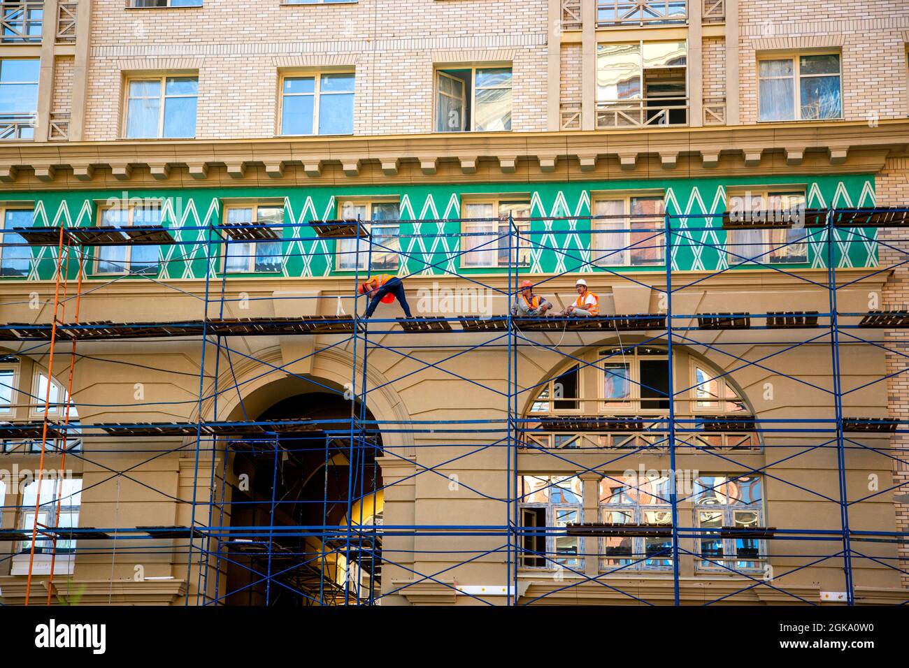Saint Petersburg, Russia - July 09, 2021: Builders perform facade work ...