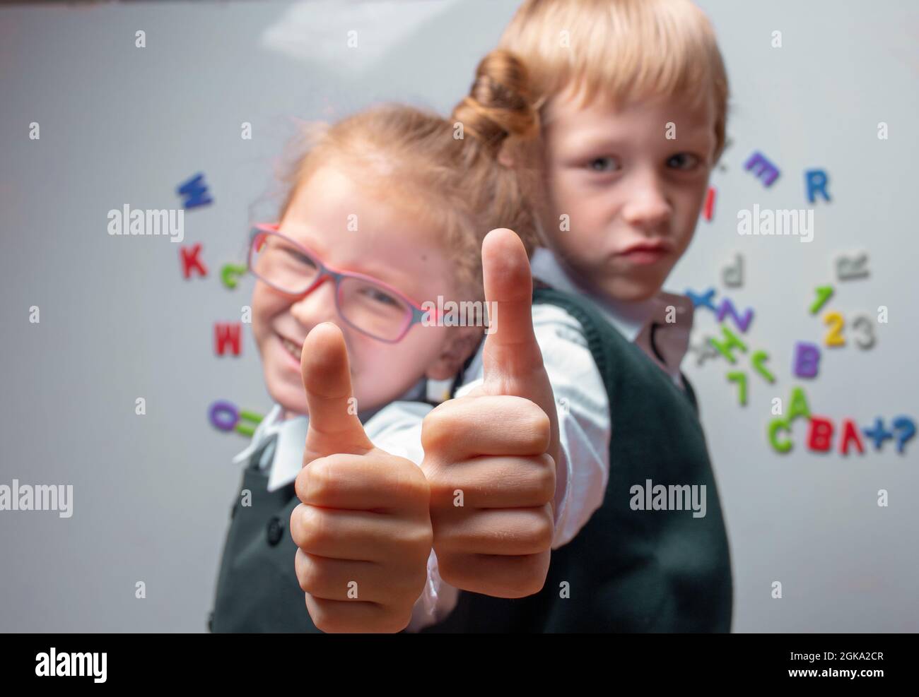 Portrait of happy pupils rising thumbs up Stock Photo - Alamy