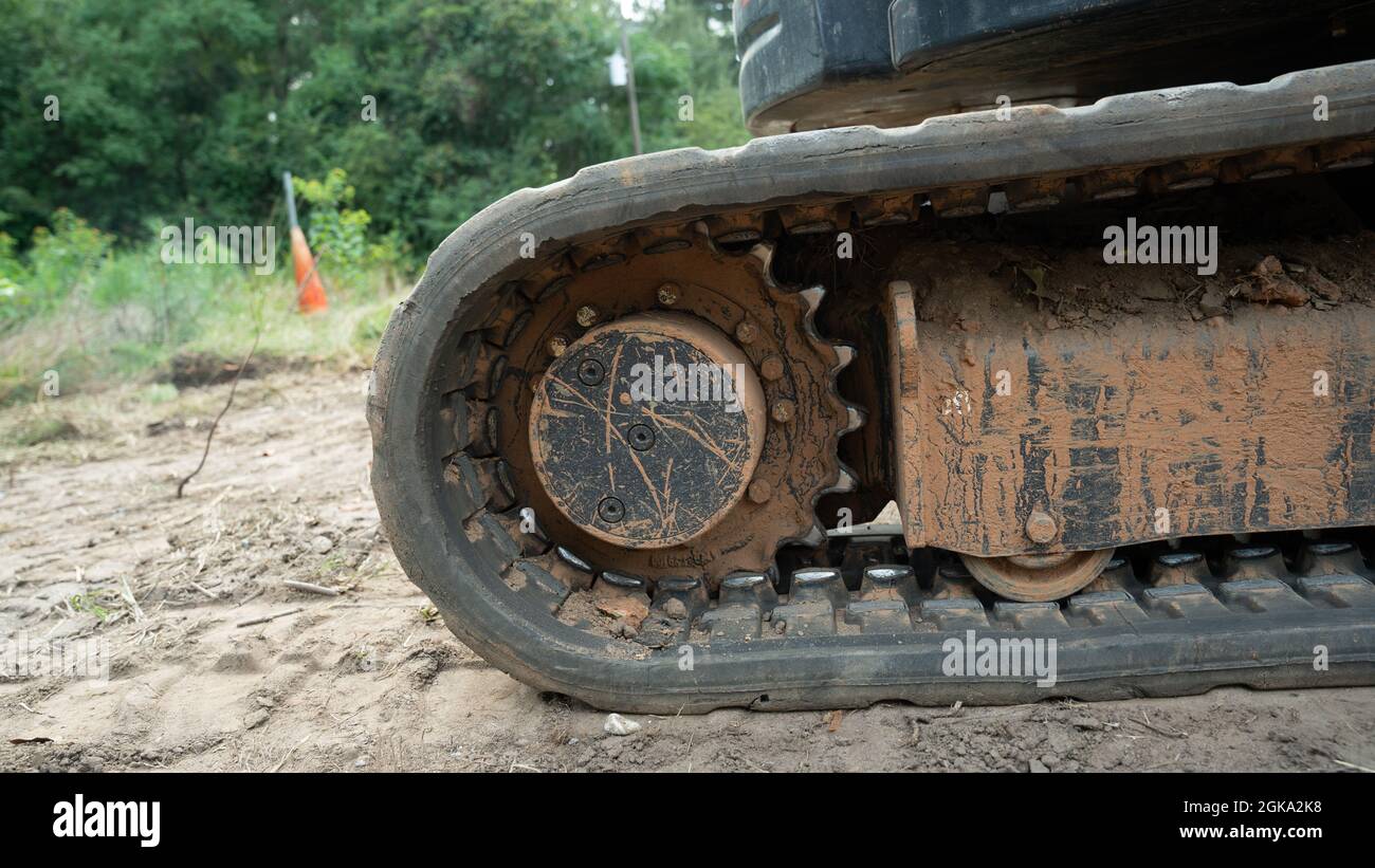 yellow yanmar backhoe demolishing old brick chimney to clear a lot ...