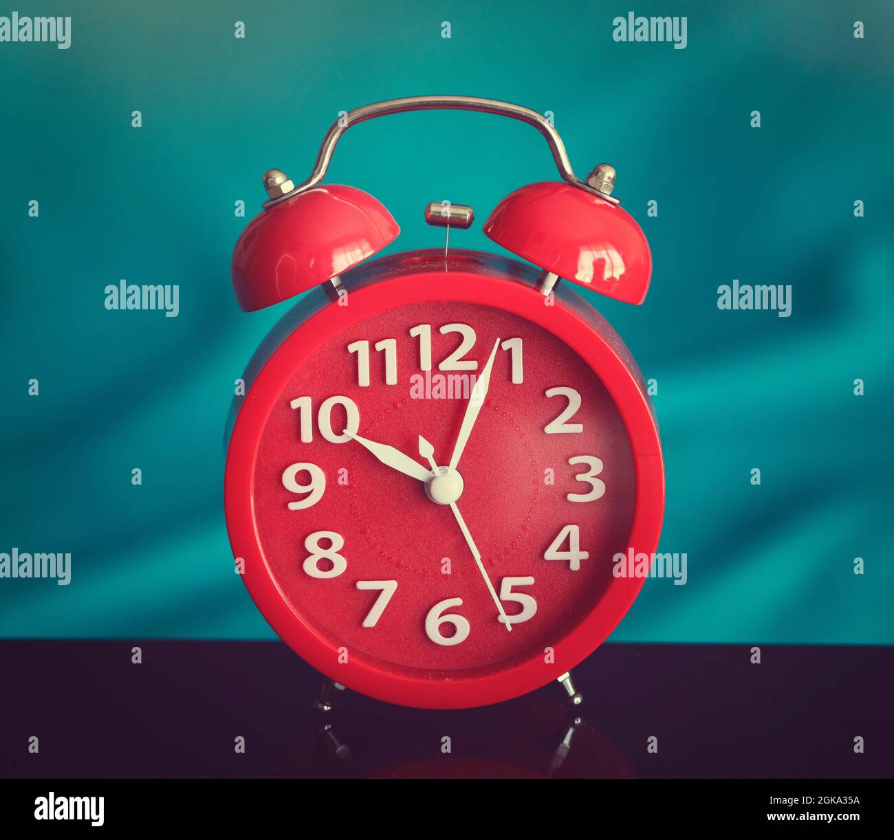 Closeup on clockwise. Face of red Alarm clock at 10 O'clock Stock Photo ...
