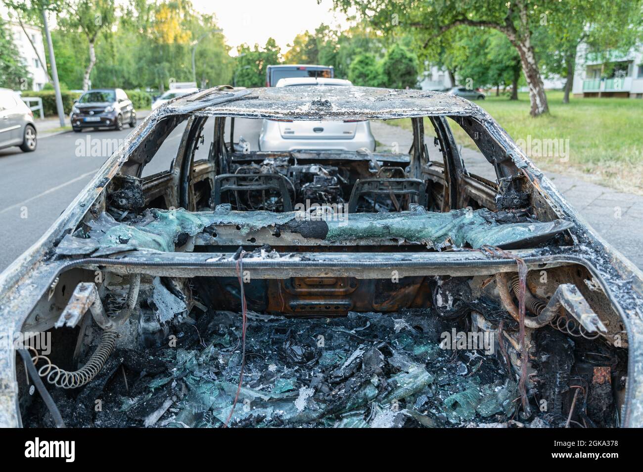 Burnt out Mercedes in the residential area by the roadside. Rear view ...