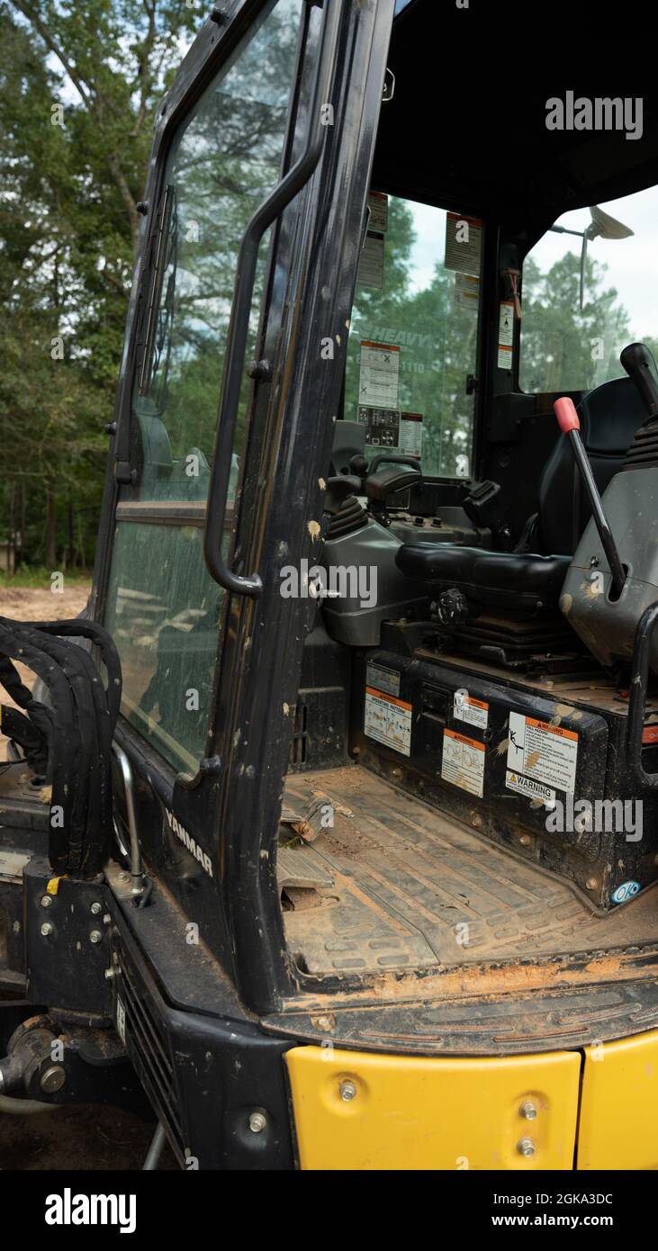 yellow yanmar backhoe demolishing old brick chimney to clear a lot ...