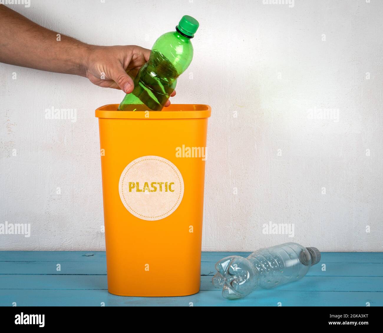 Plastic waste sorting container. A man's hand with a pet bottle Stock ...