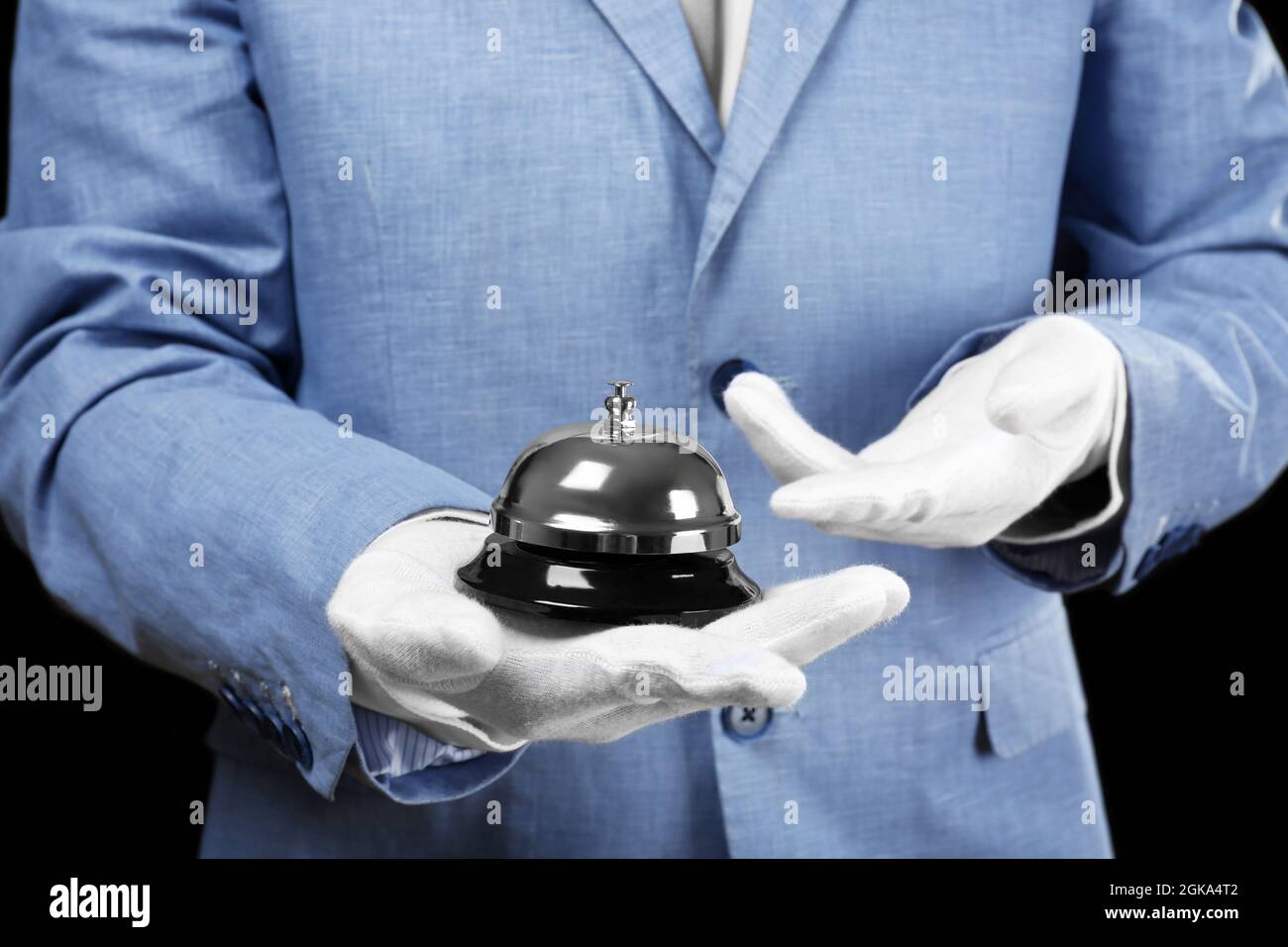 Man holding bell on black background, closeup Stock Photo - Alamy
