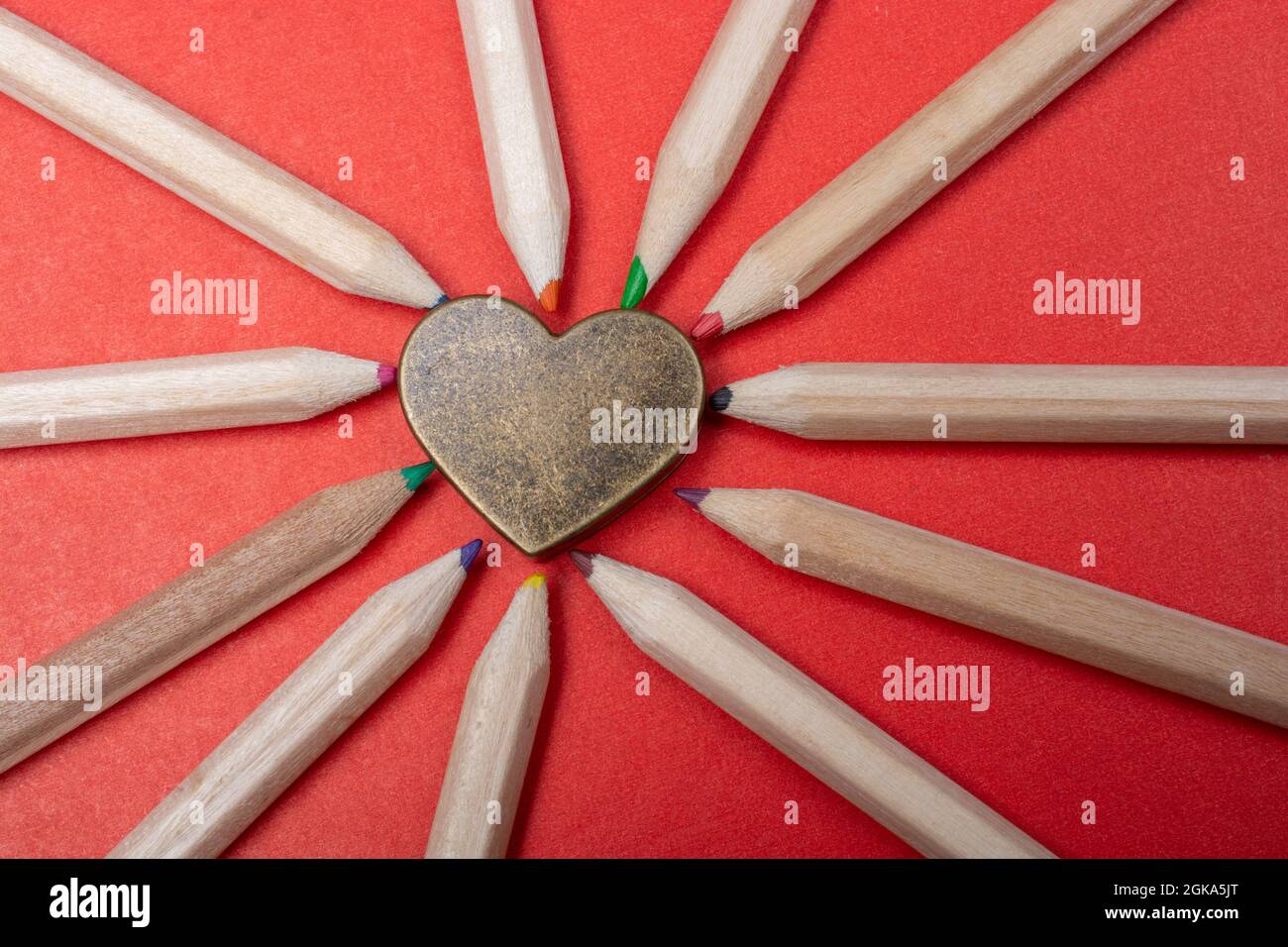 Heart laid out with sharpened multi-colored pencils Stock Photo - Alamy