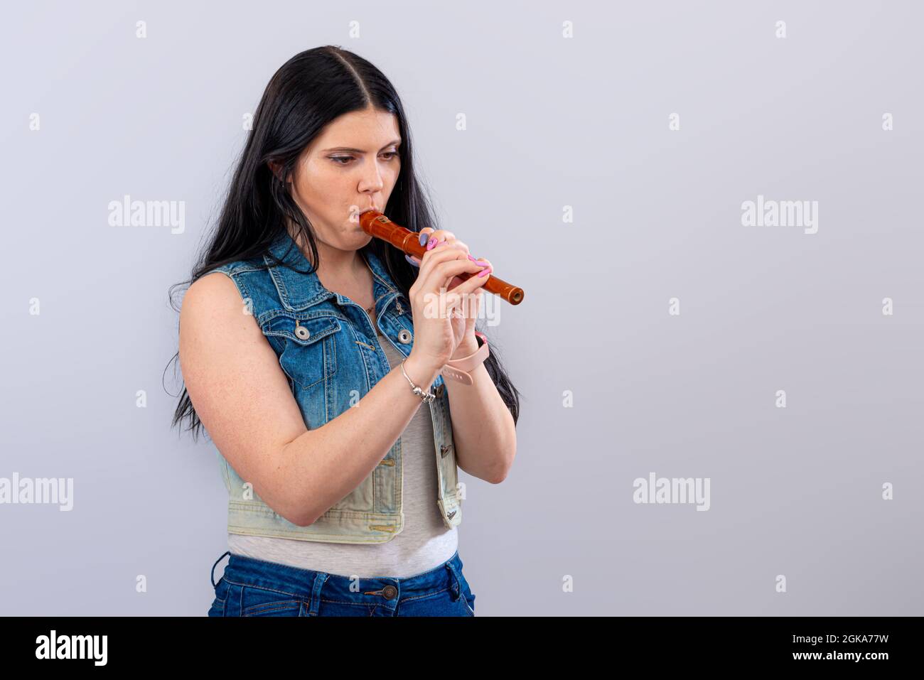 Young woman playing flute hi-res stock photography and images - Alamy