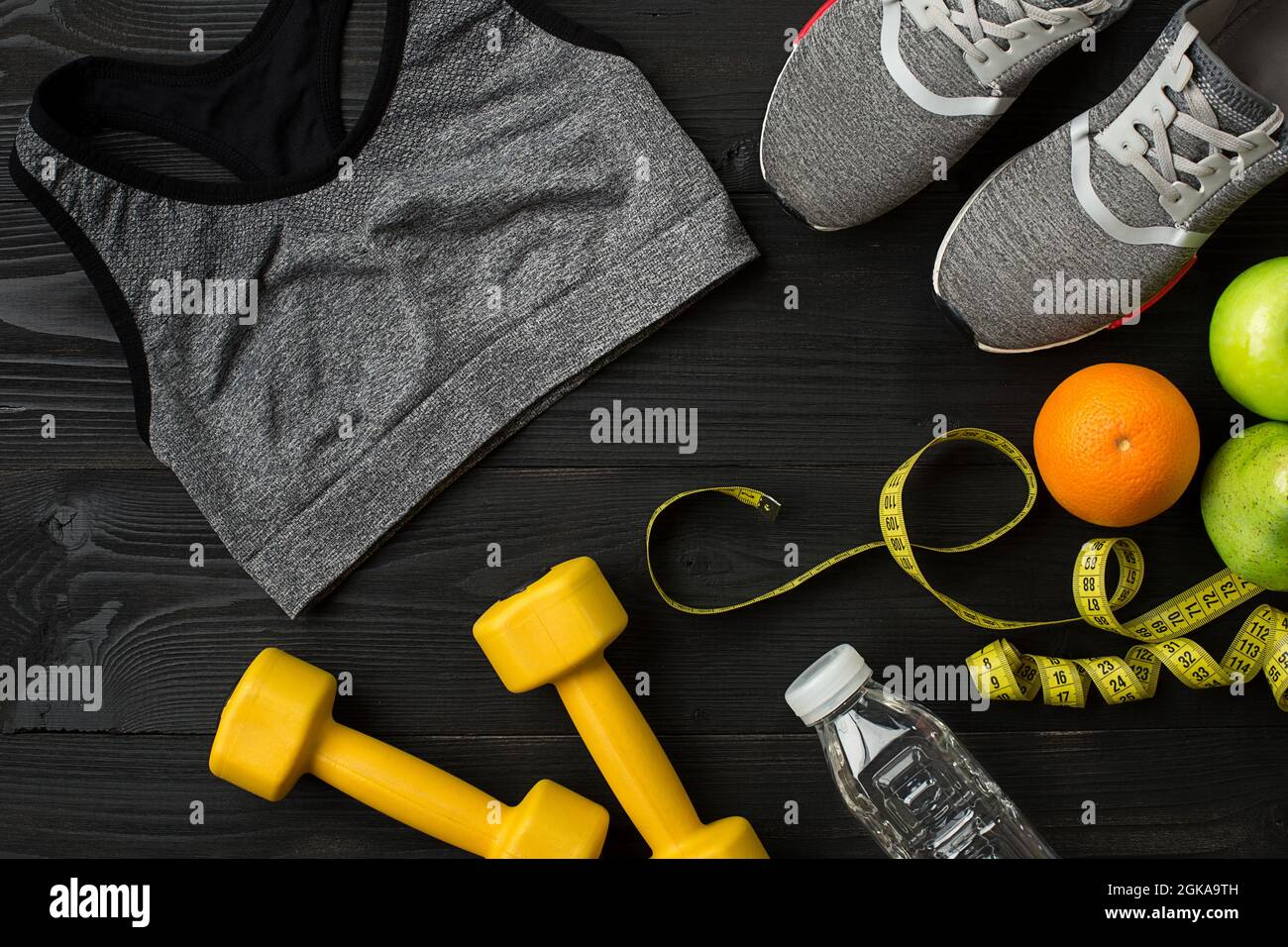 Workout plan with fitness food and equipment on dark background, top ...