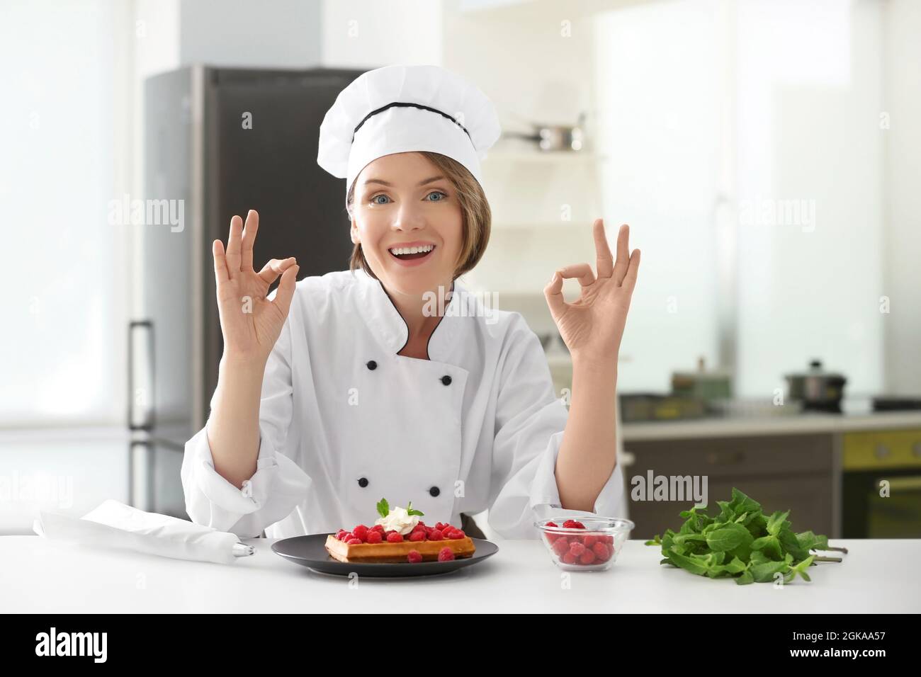 Female chef with tasty dessert in kitchen Stock Photo - Alamy