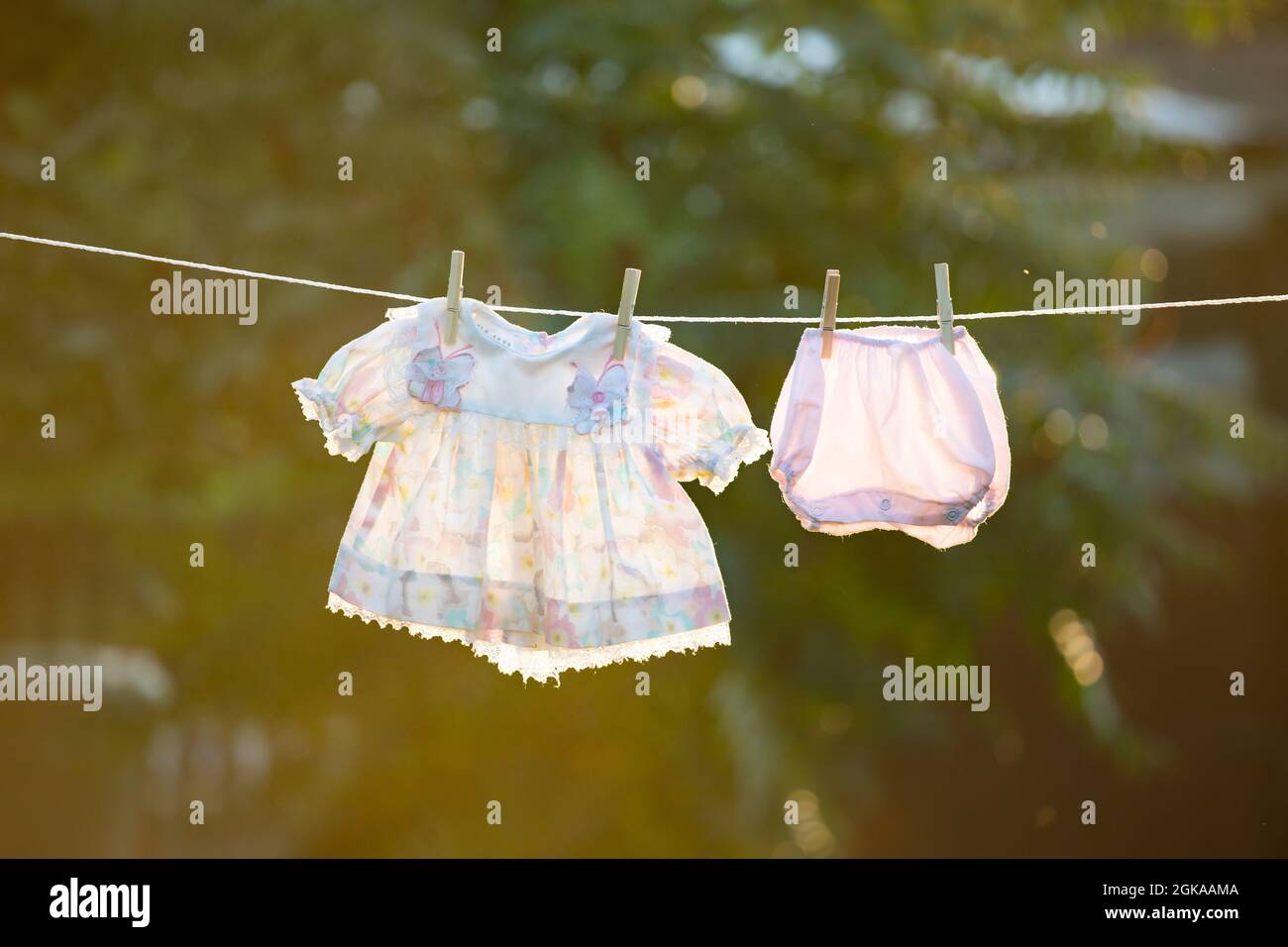 Baby clothes hanging on the clothesline Stock Photo - Alamy