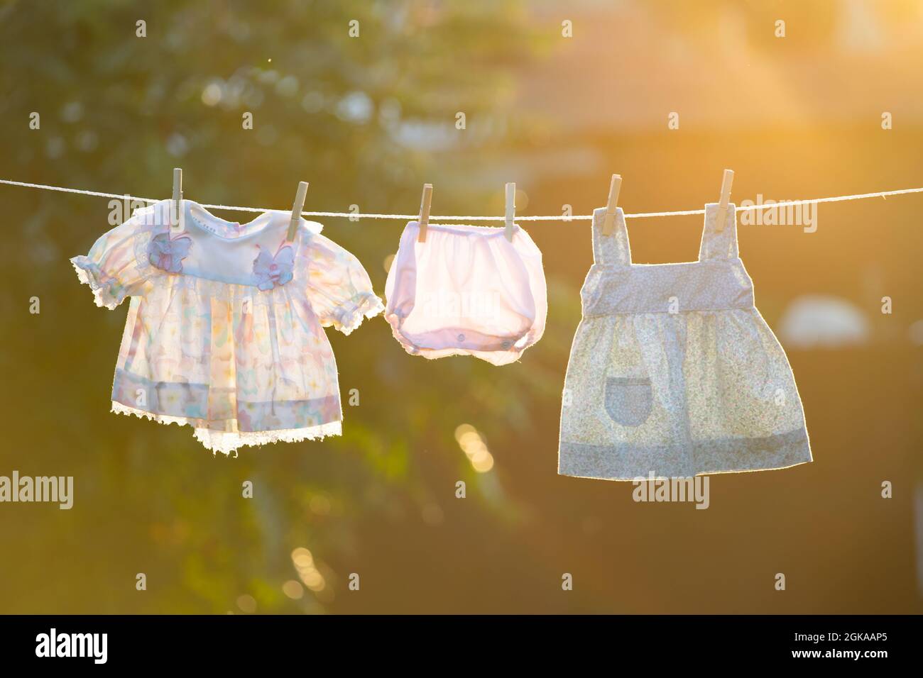 Baby clothes hanging on the clothesline Stock Photo - Alamy