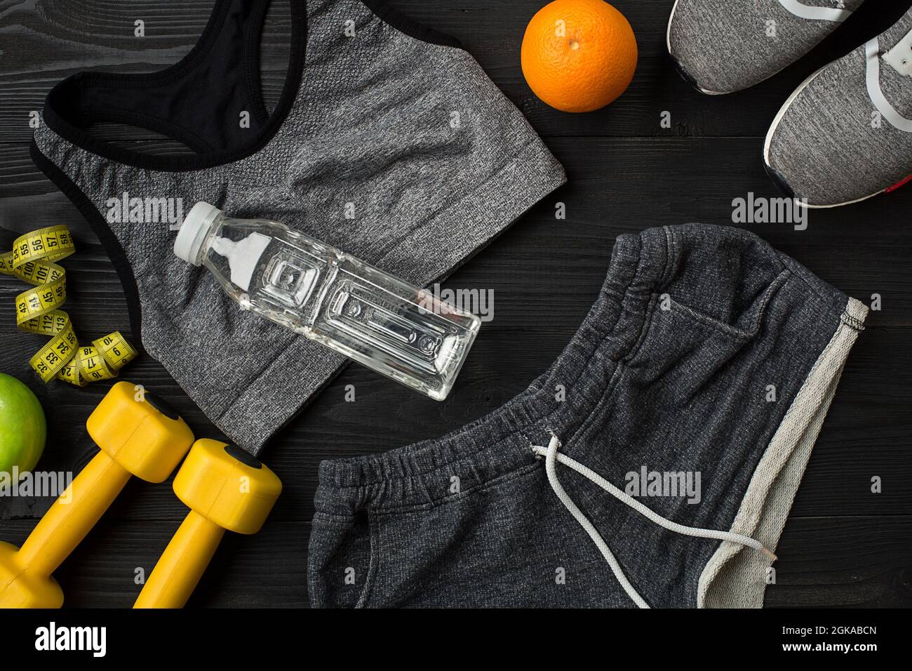 Workout plan with fitness food and equipment on dark background, top ...